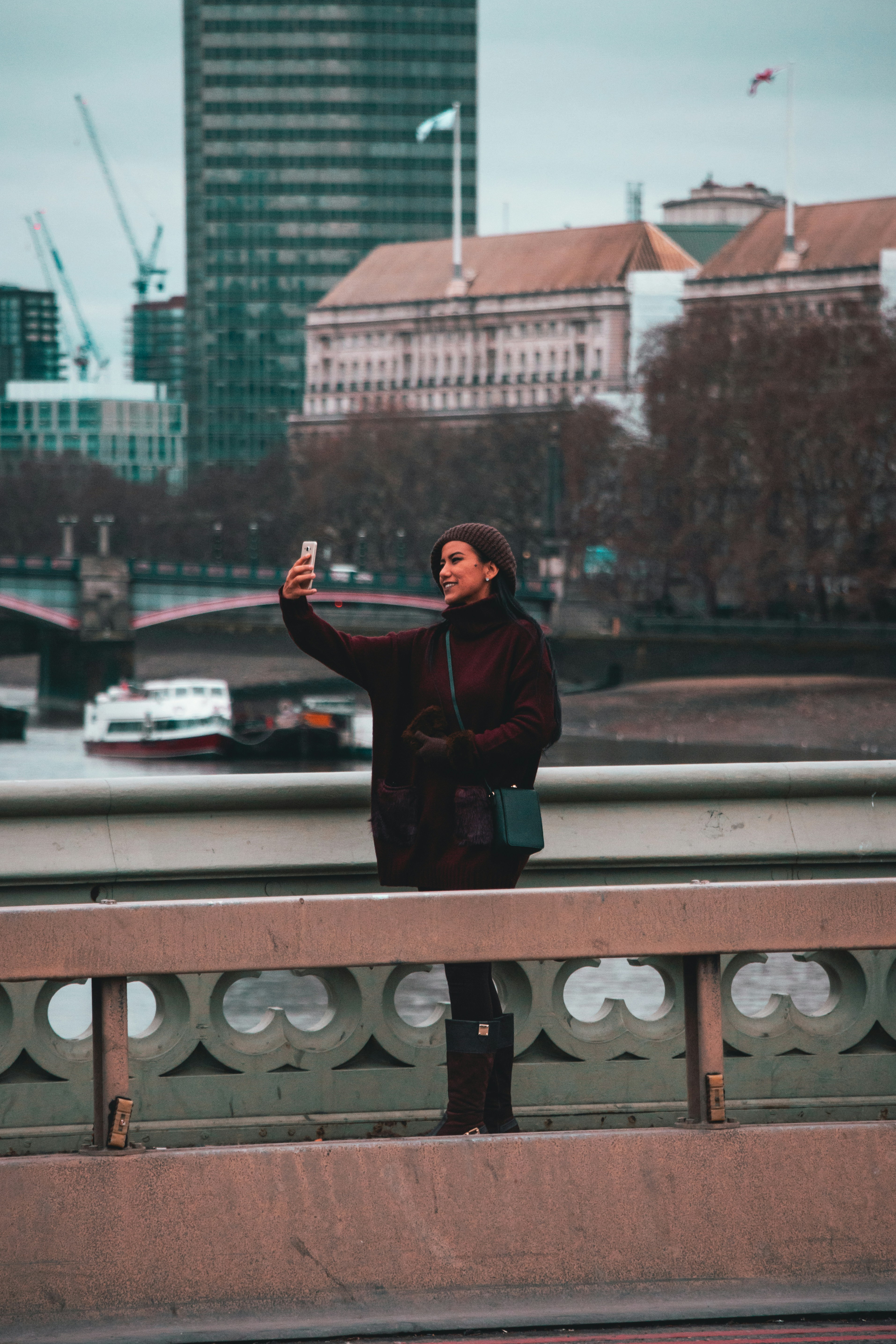 Selfie on the Thames: Cityscape Backdrop with a Confident Pose