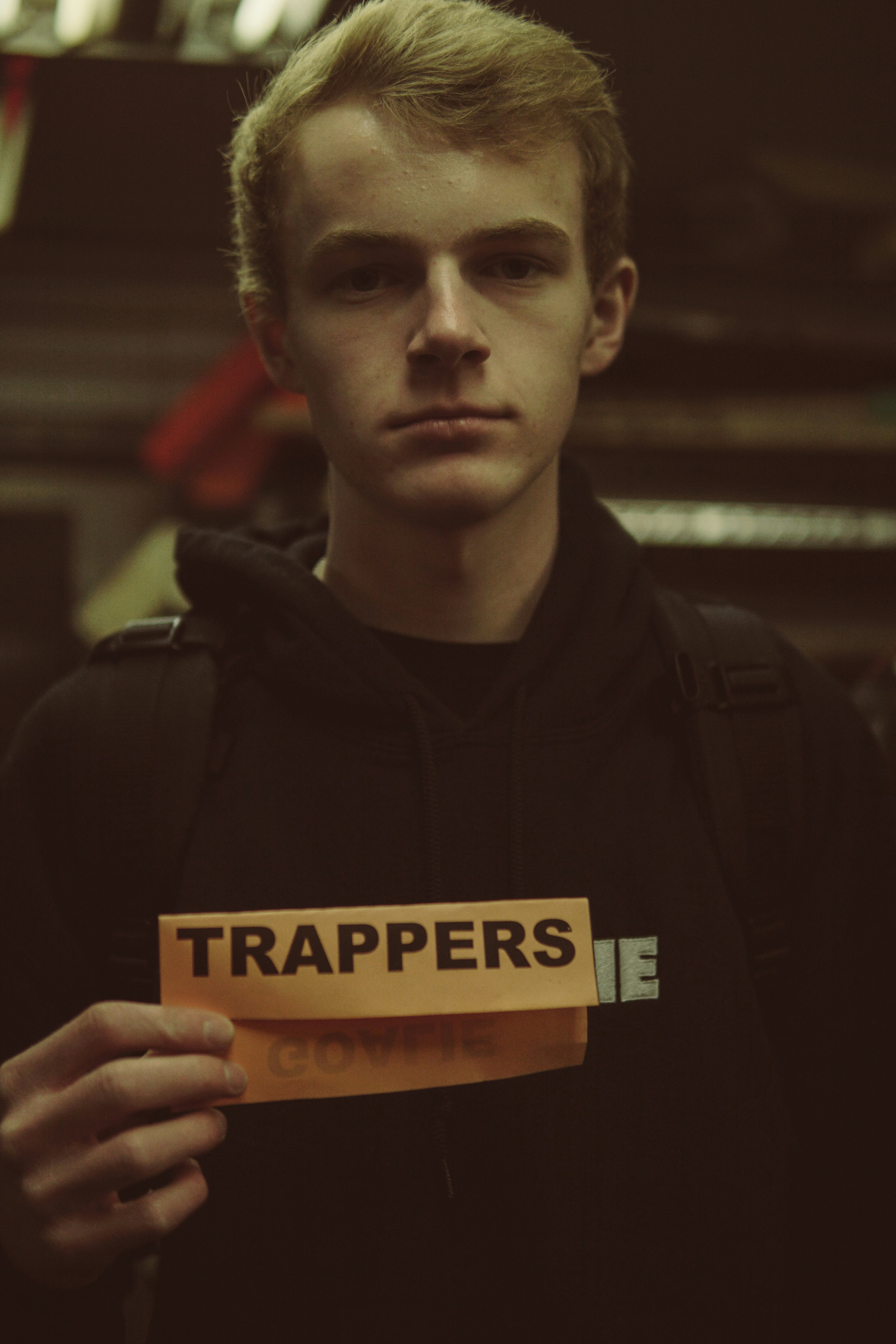 Man standing and holding Trappers sign photo – Free Black Image on Unsplash