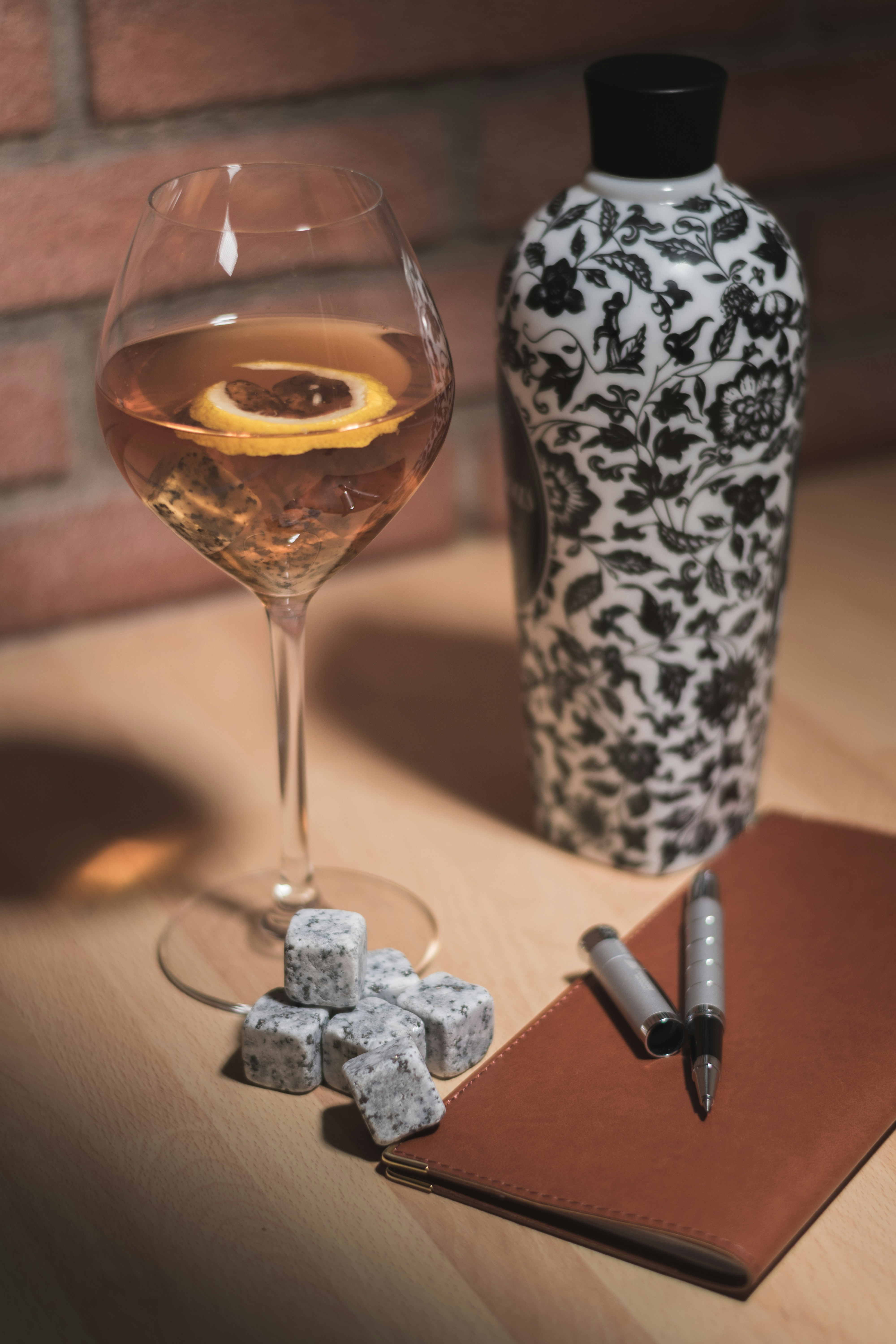 Lemon Twist in Focus: A Quiet Still Life with a Floral Decanter