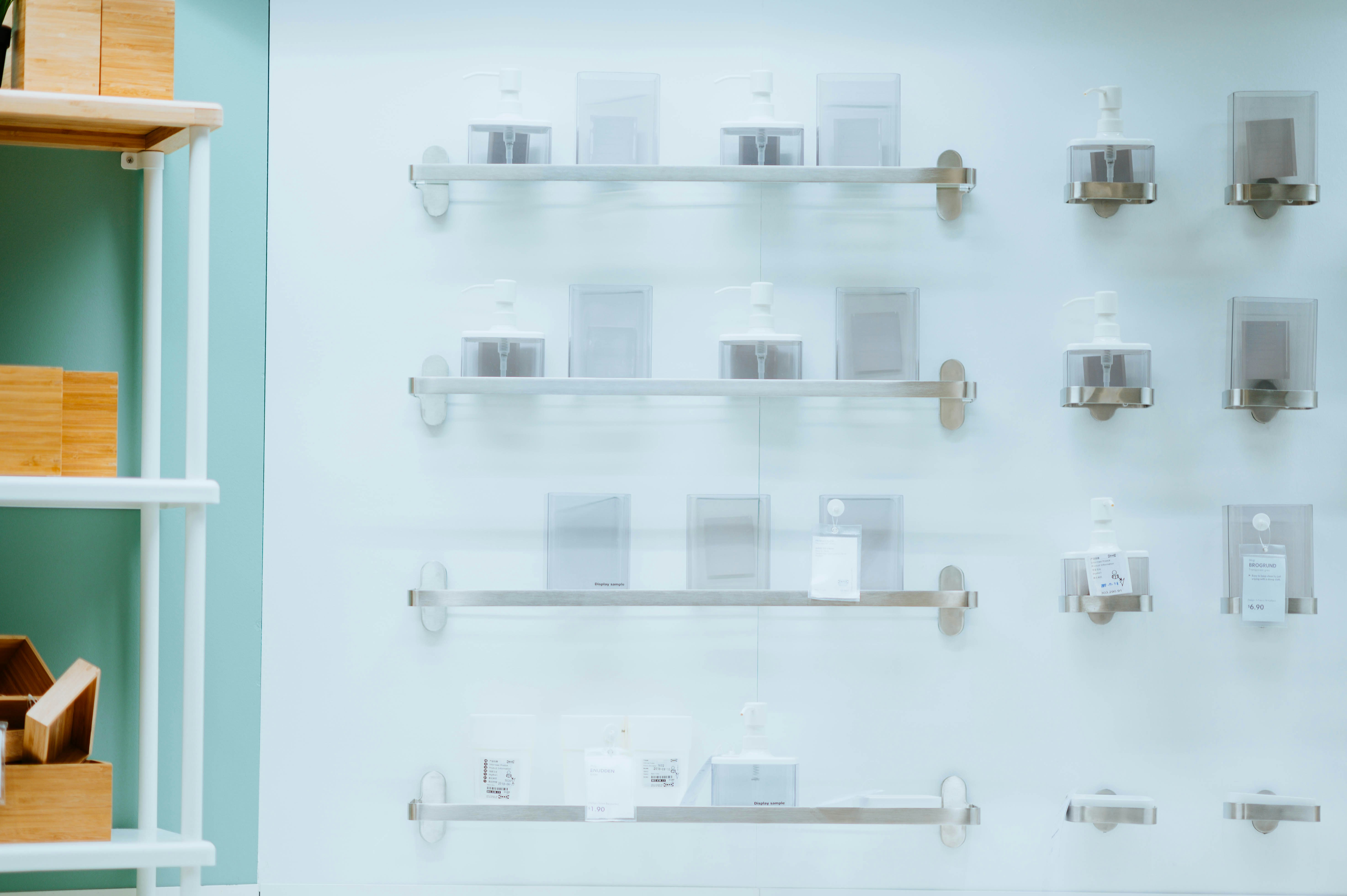Pastel Precision: A Quiet Wall of Glass Shelves Displaying Tiny Goods