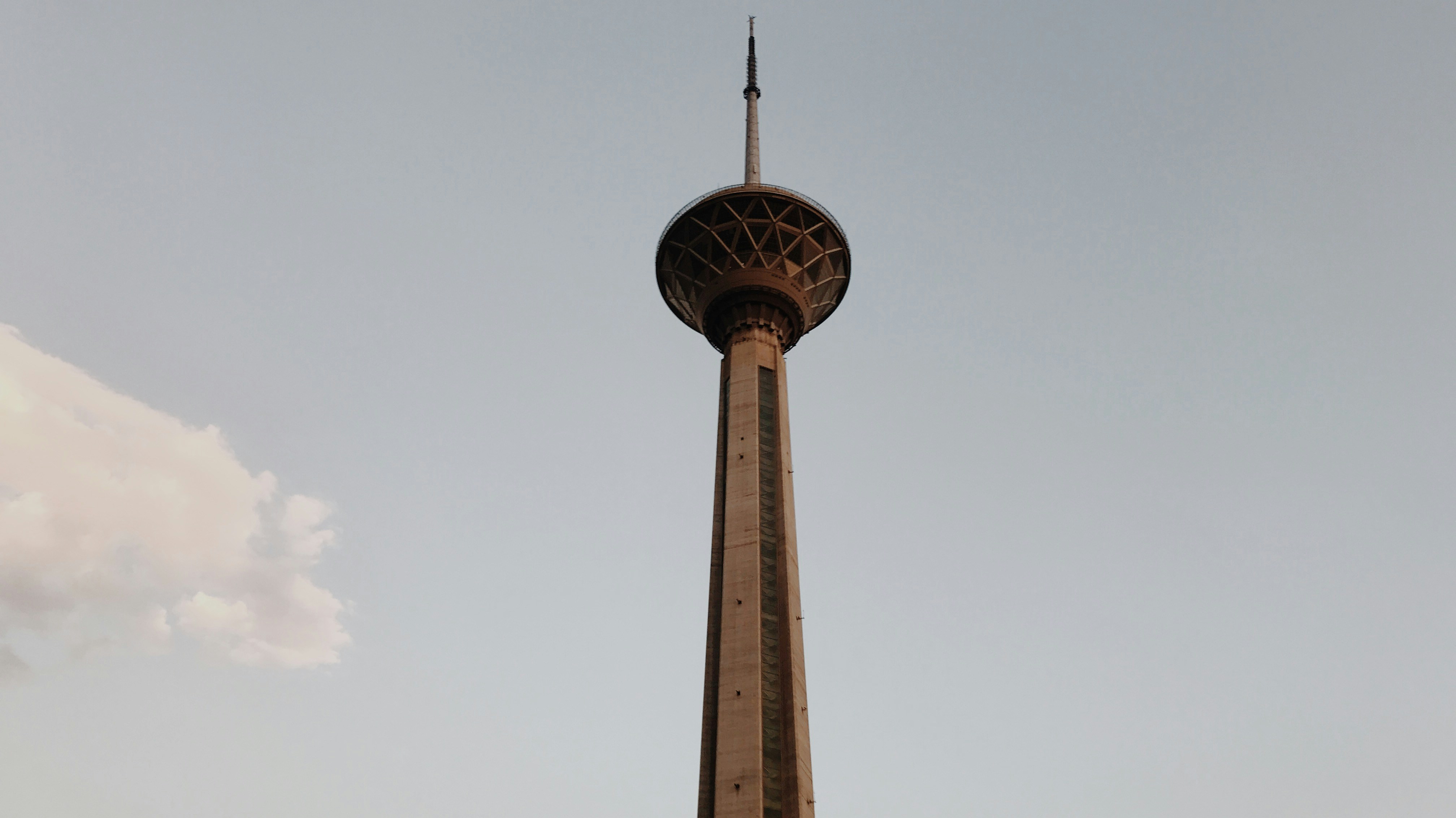 Crown of Steel: Fernsehturm Looms Over a Pale Blue Sky