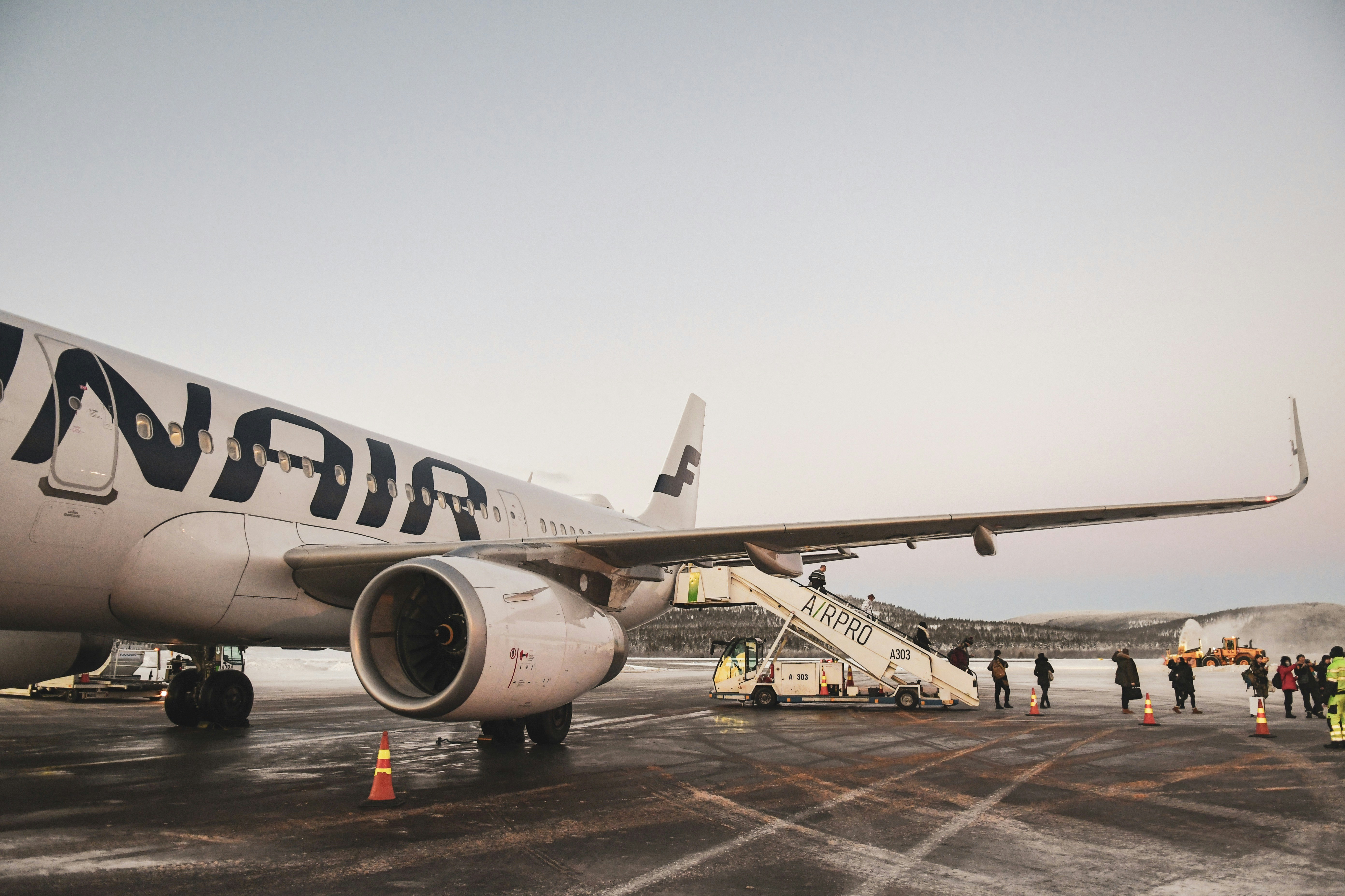 Dusk on the Tarmac: A Jet, a Mobile Stair, and Ground Crew in Quiet Motion