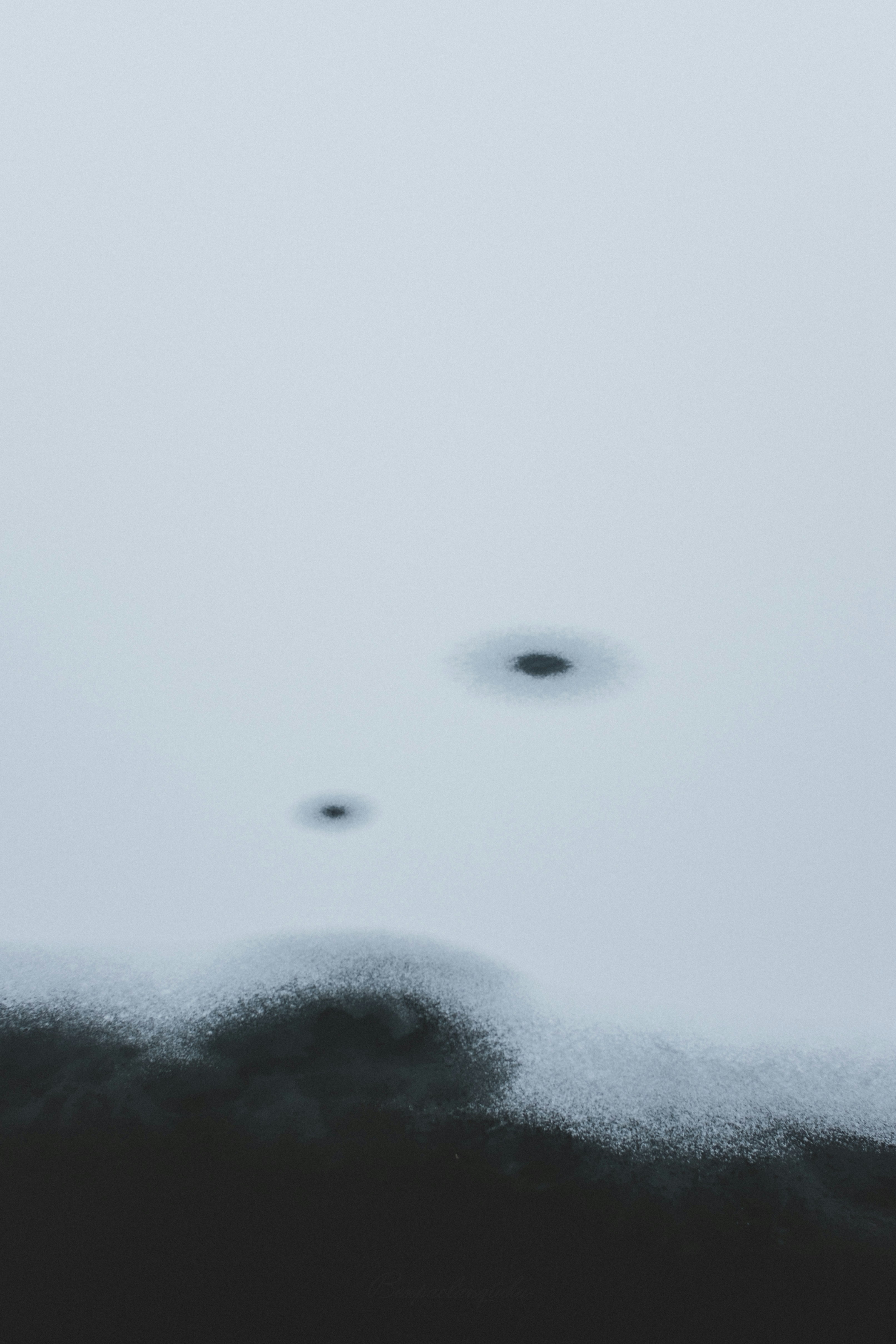 Two Shadow Orbs on a Quiet Snowfield