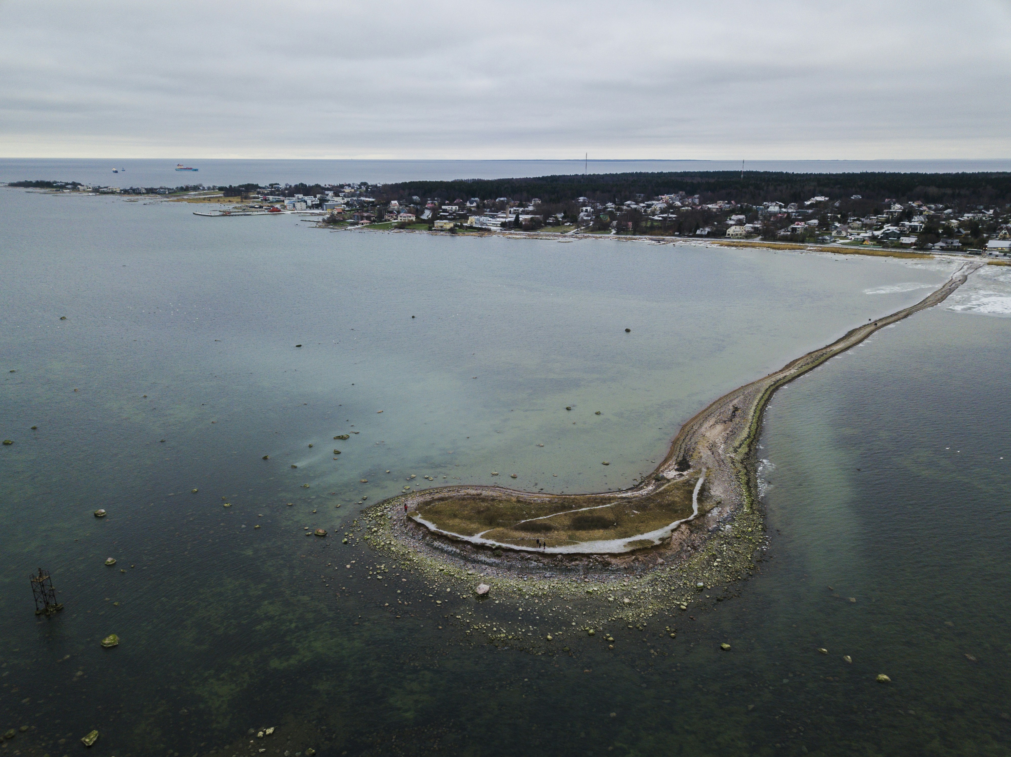 Ringed Sandbar Cradling a Quiet Coastal Village