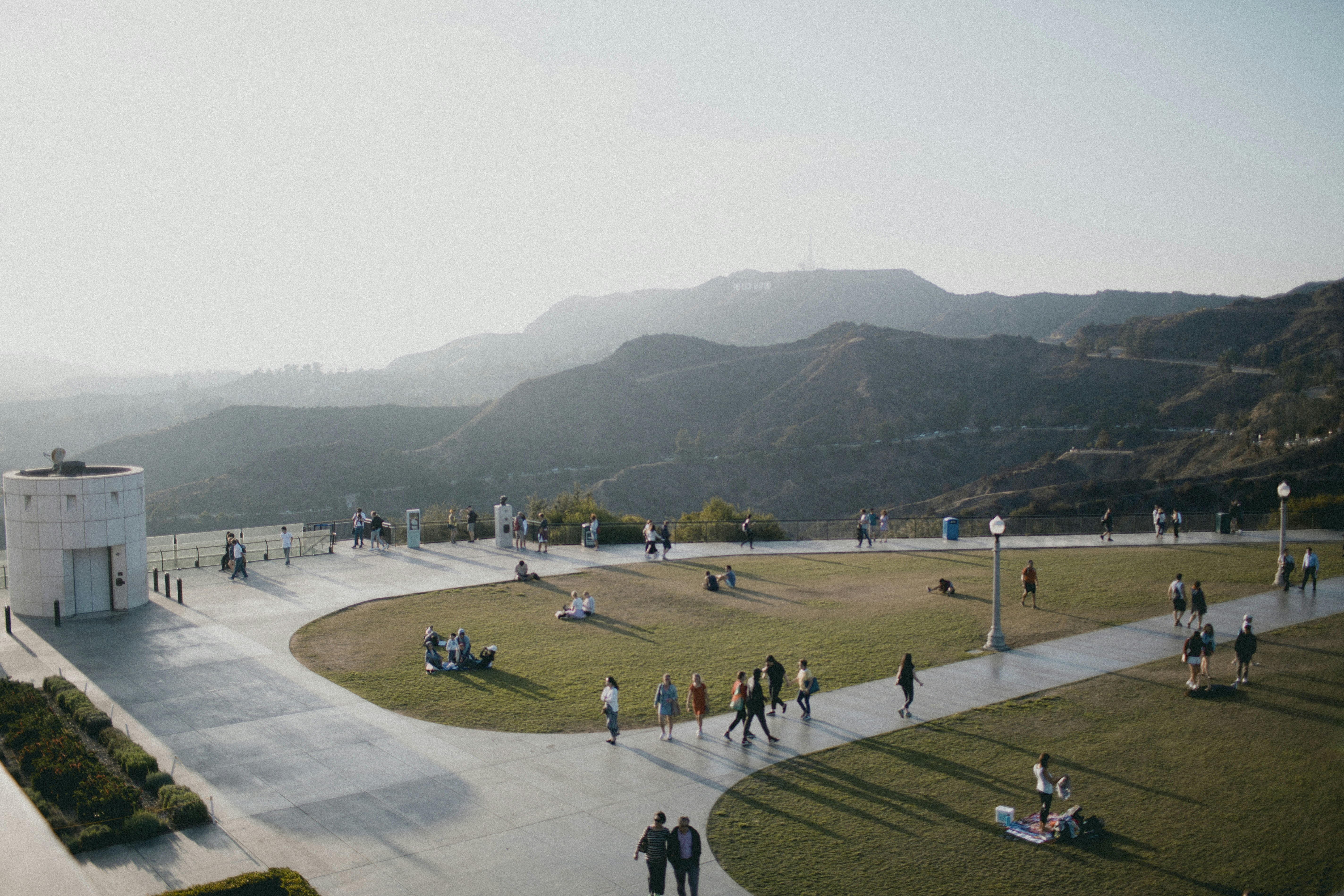 Aerial photography of people around open field near mountains photo ...