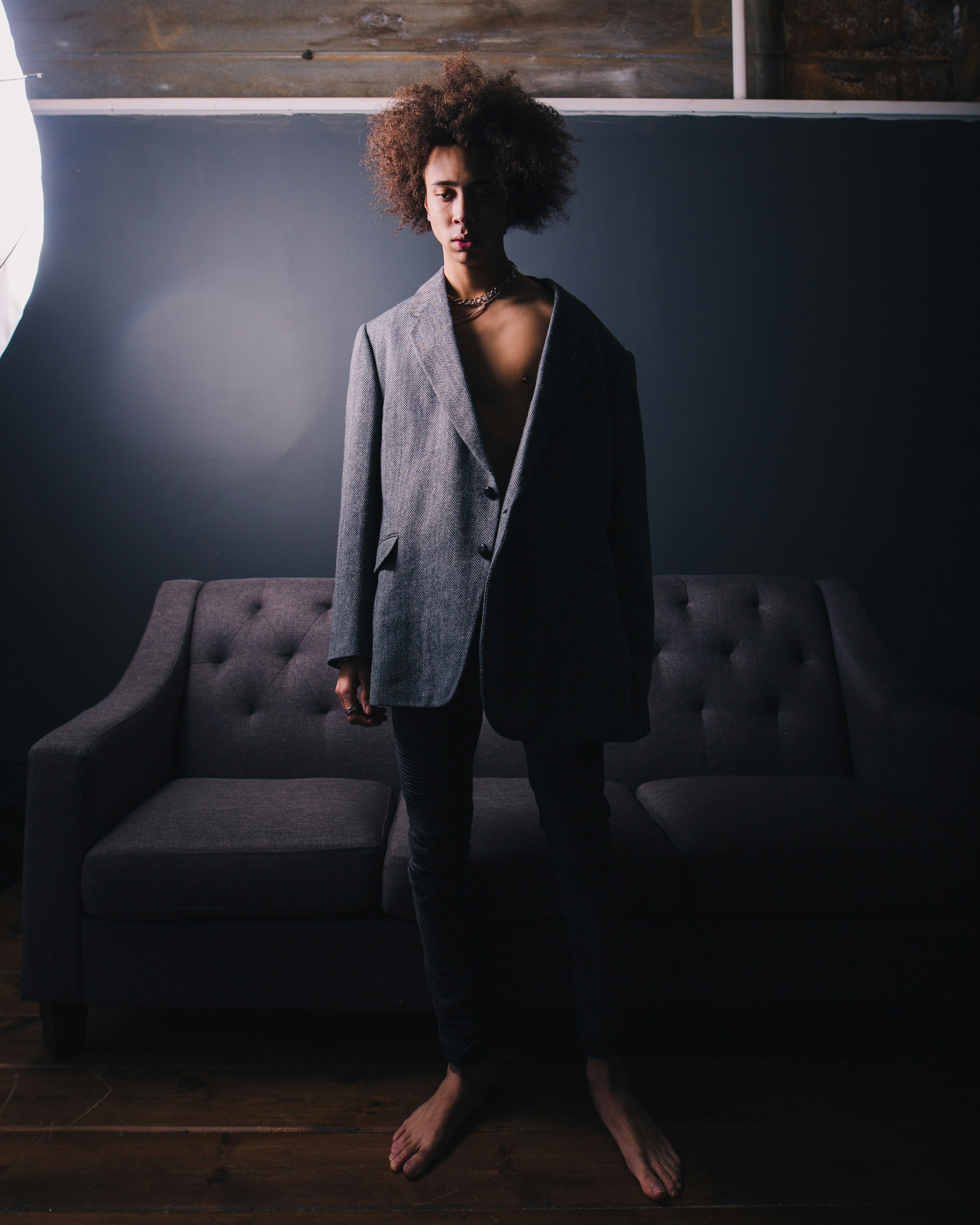 Man standing wearing black blazer behind sofa photo – Free Cartersville ...