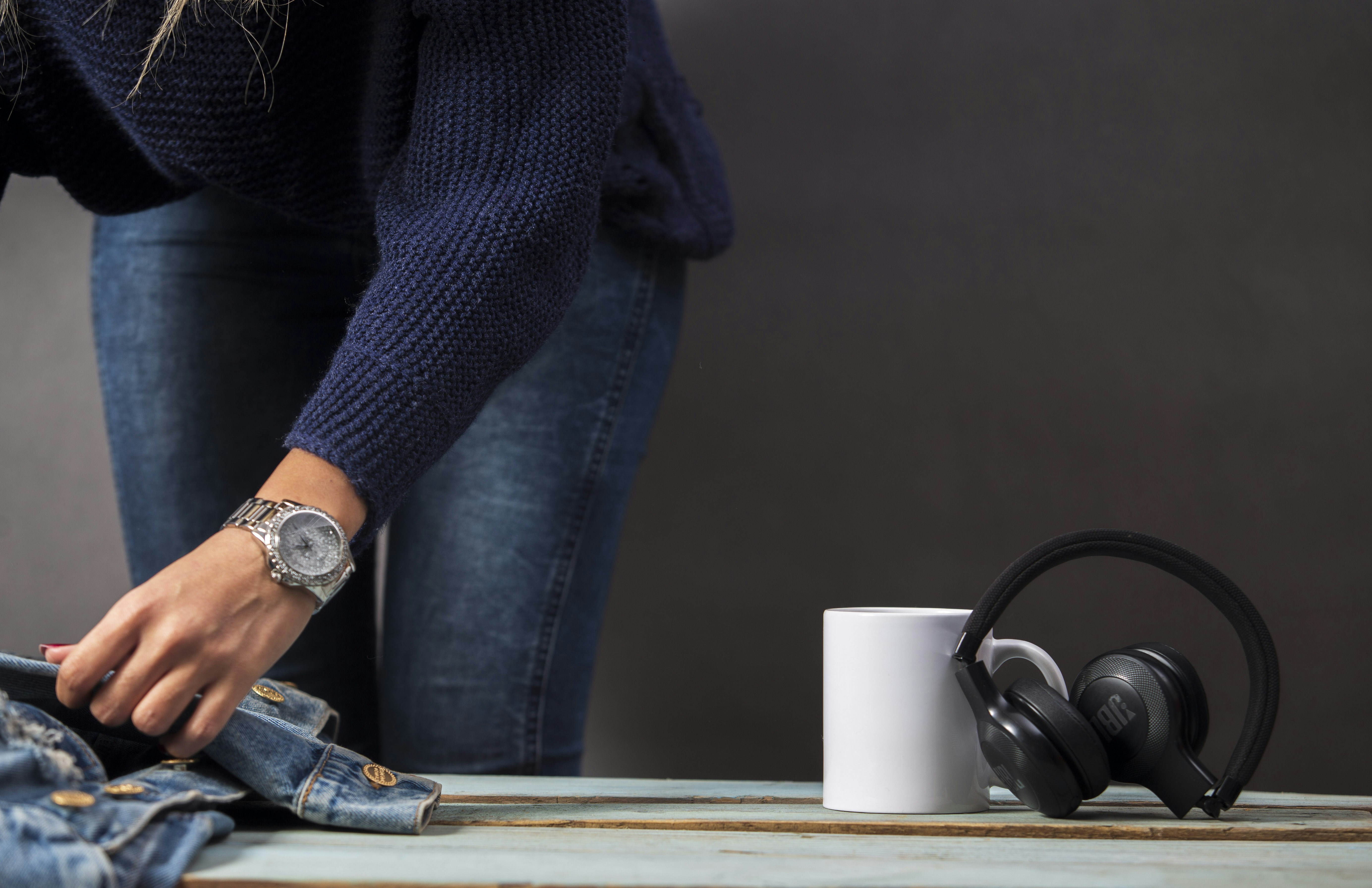 Wristwatch in Focus: Quiet Folding of Denim on a Wooden Table