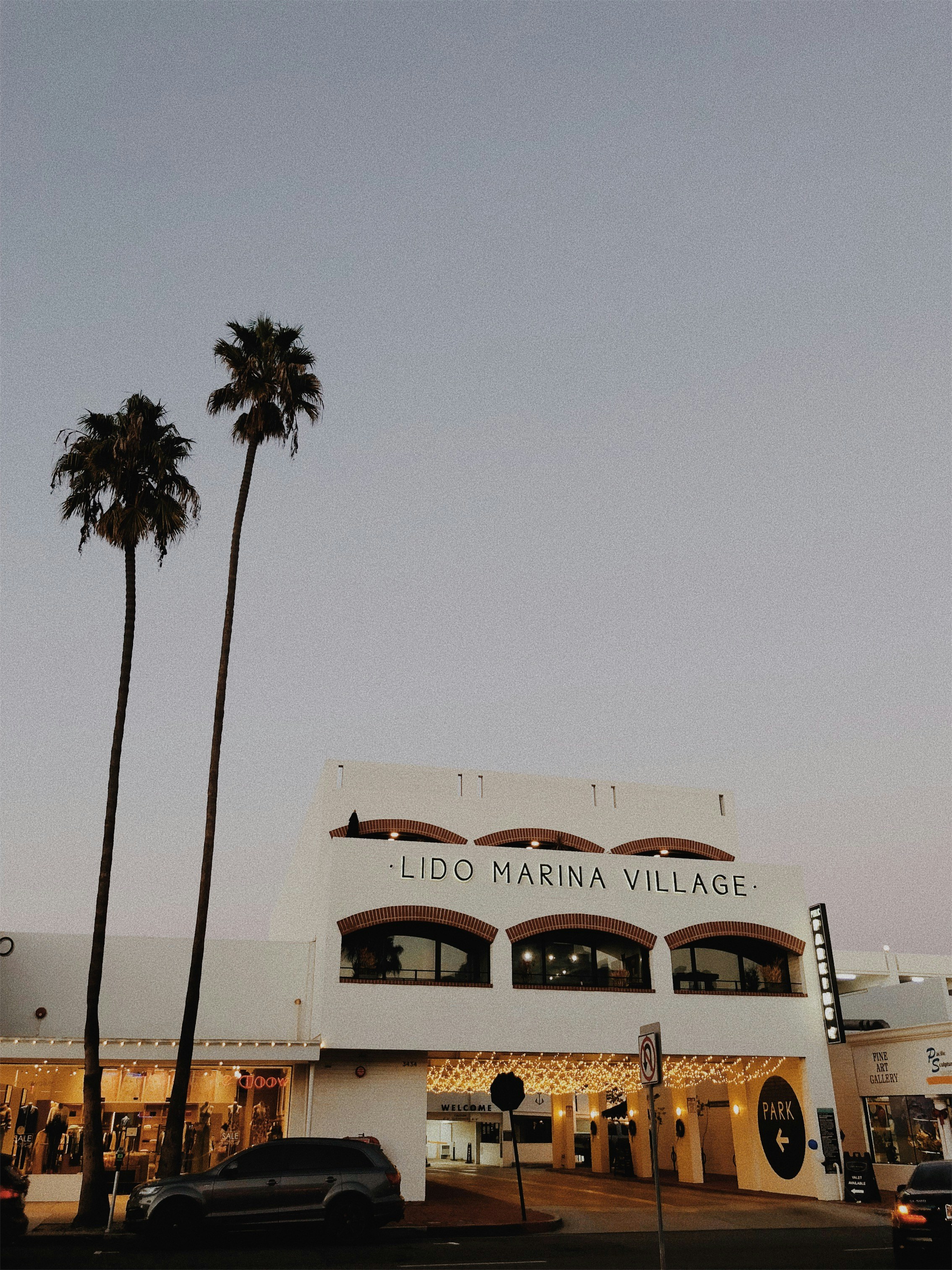 Palm-Topped Facade: Lido Marina Village in Quiet Light