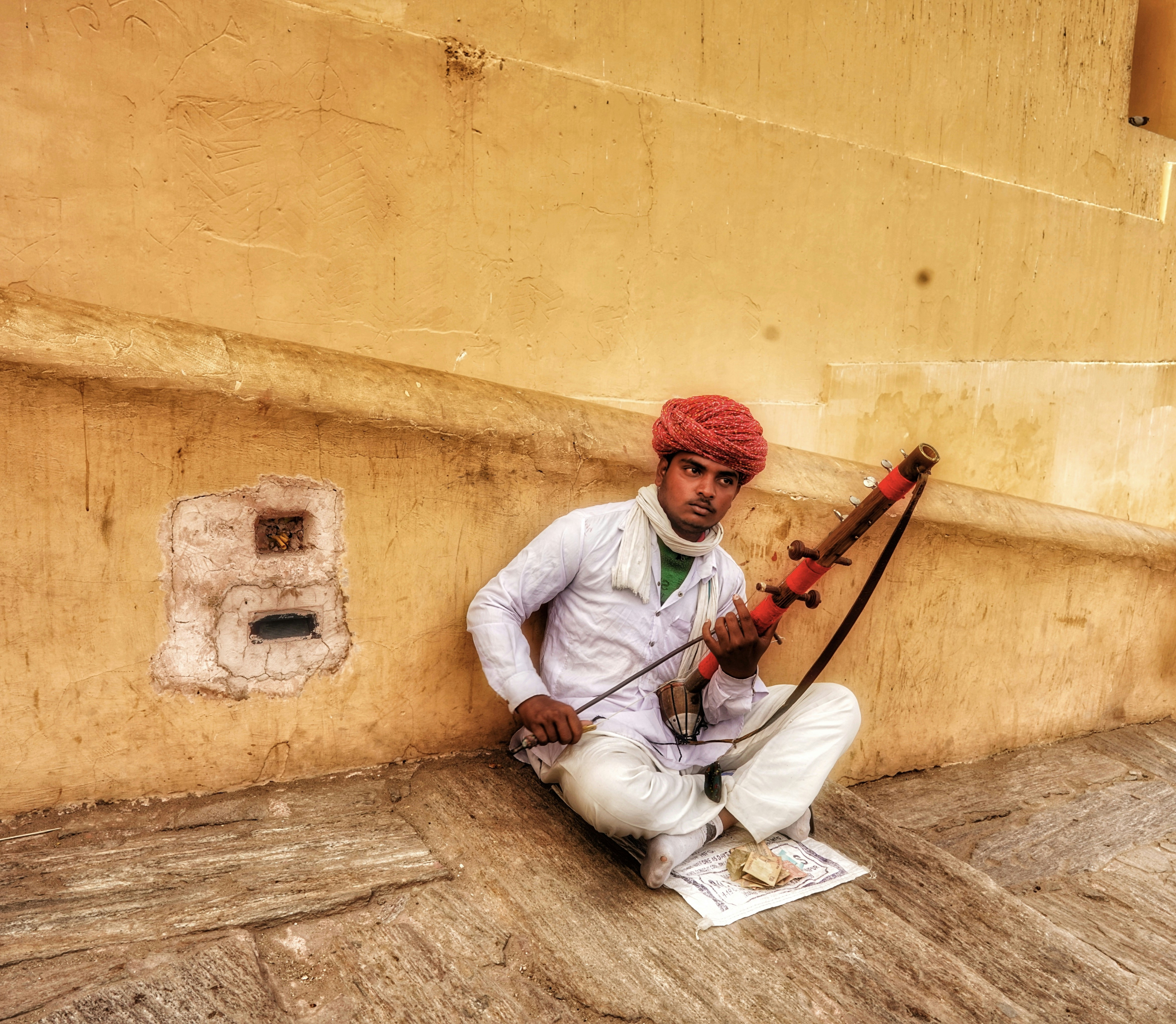 Man sitting and holding string instrument photo – Free Human Image on ...