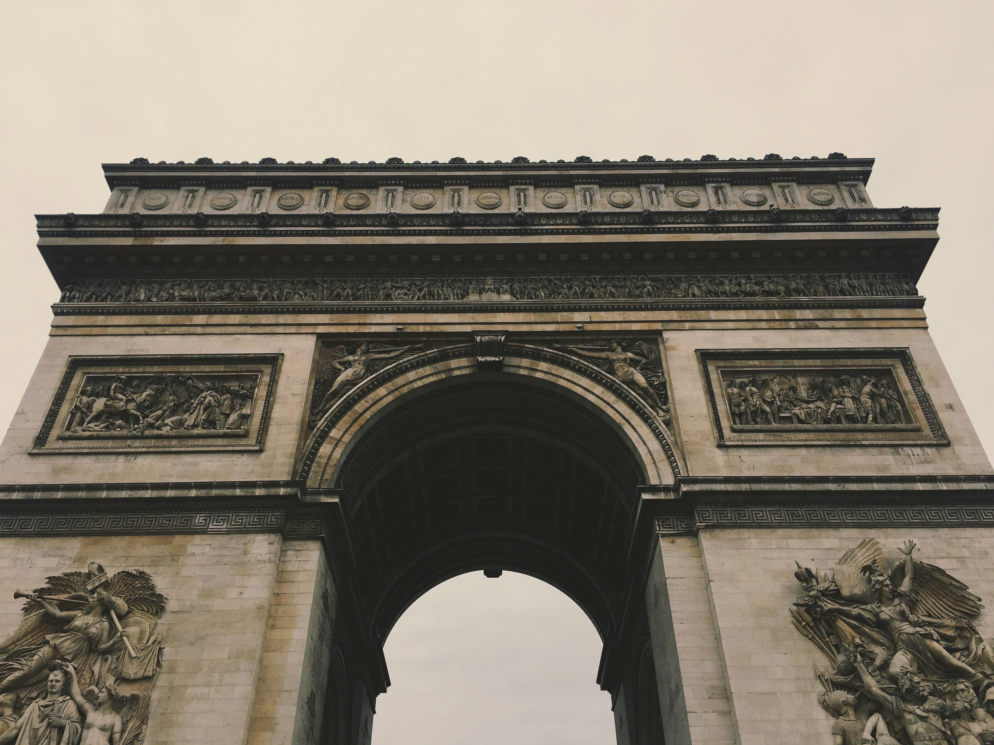 Low-Angle Reverie: Stone Arch Framed by Carved Reliefs