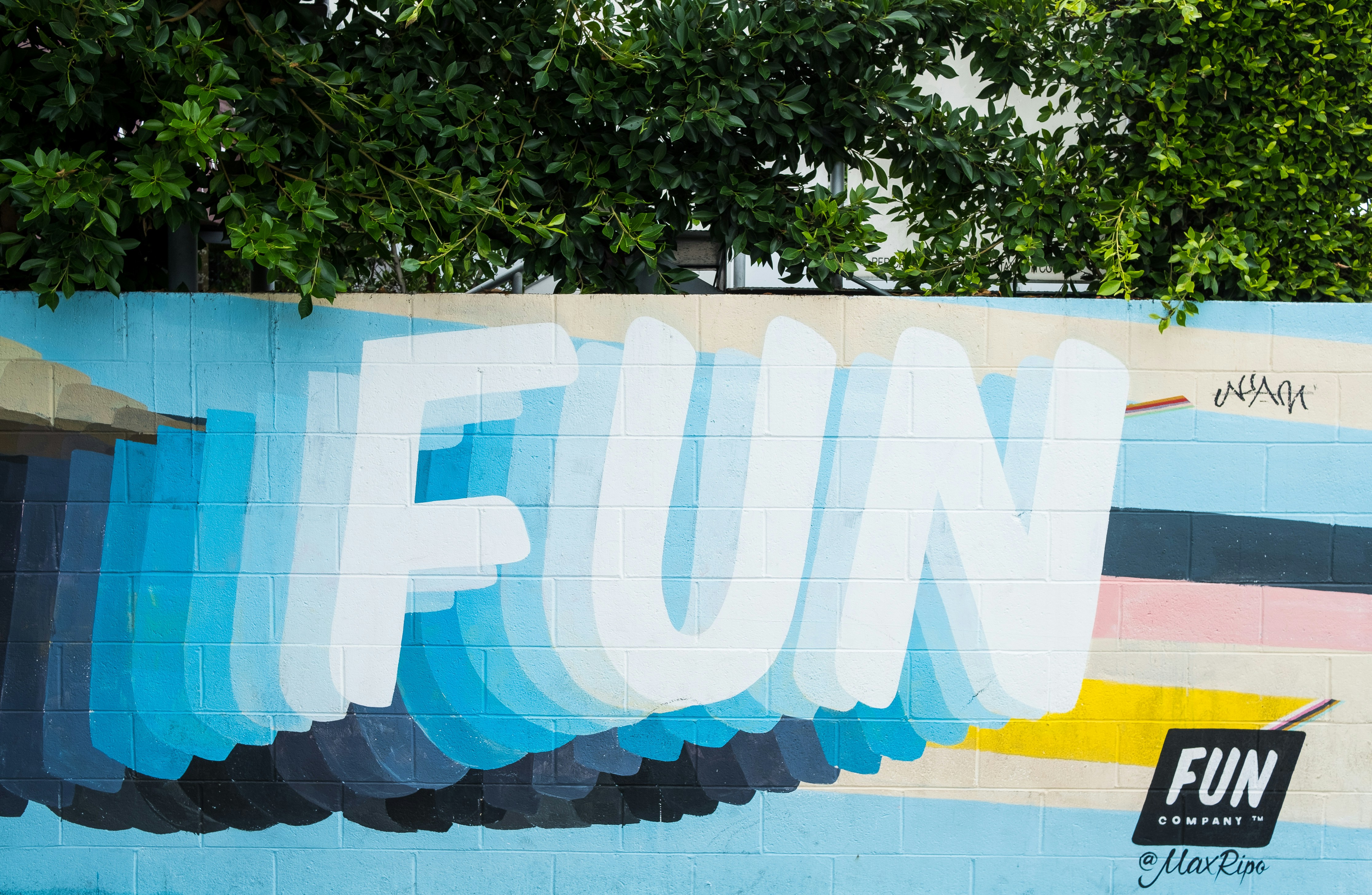 Three-Dimensional Aqua Letters Spell FUN on an Urban Wall