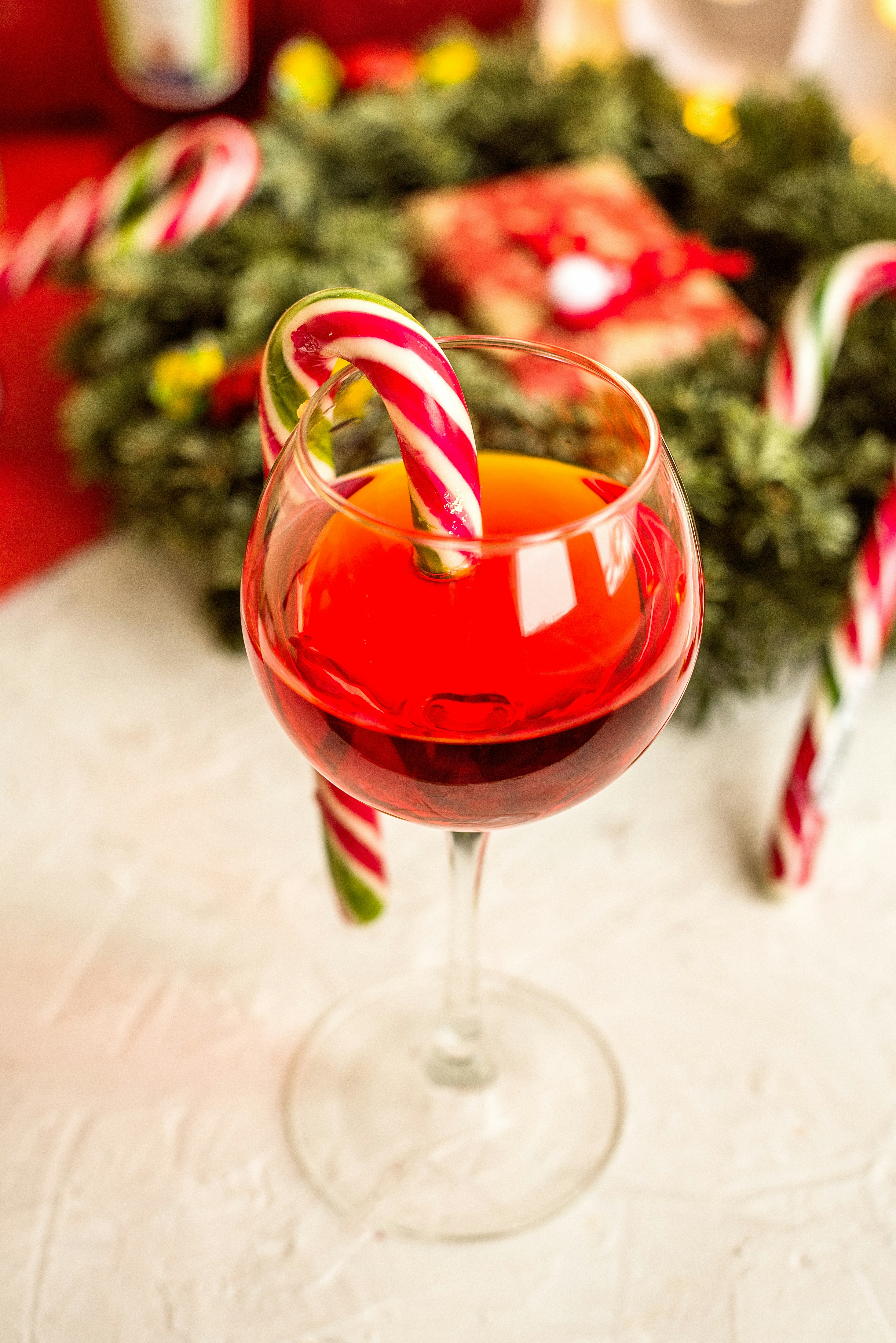 A glass filled with a red liquid and candy canes photo – Free Image on ...