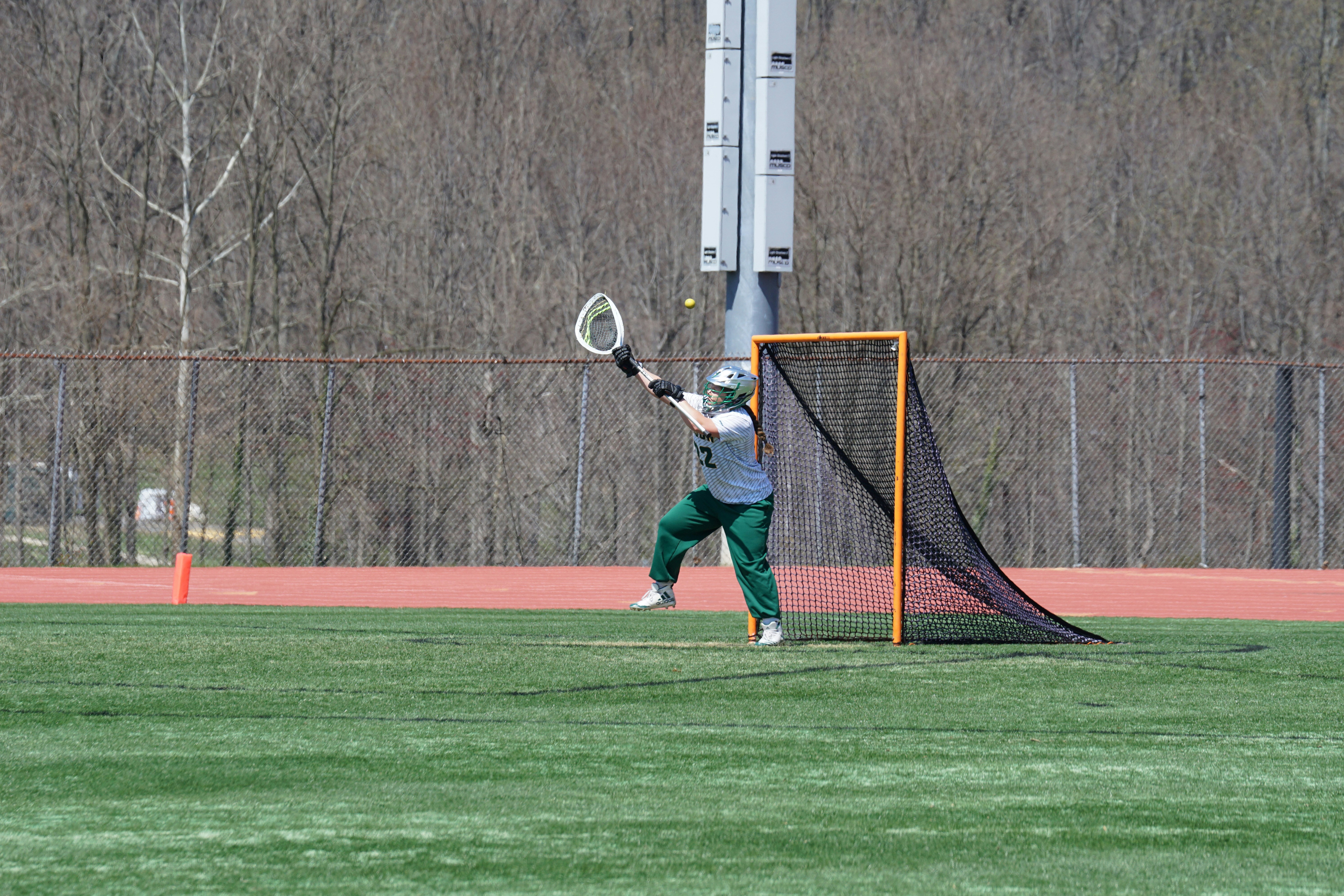Man standing on field holding lacrosse stick photo – Free Grey Image on ...
