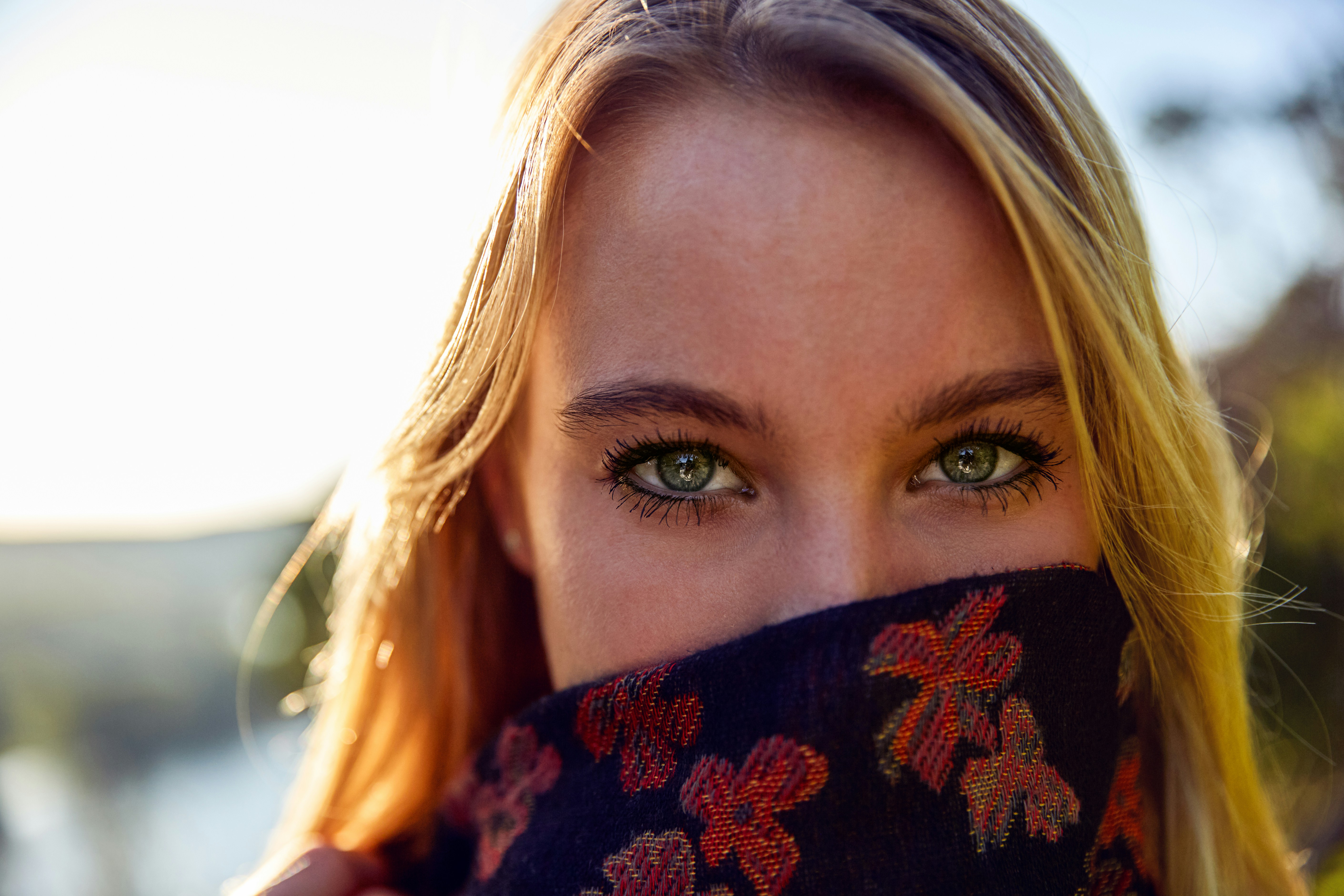 Eyes Above the Mask: Focused Gaze in Warm Backlit Portrait