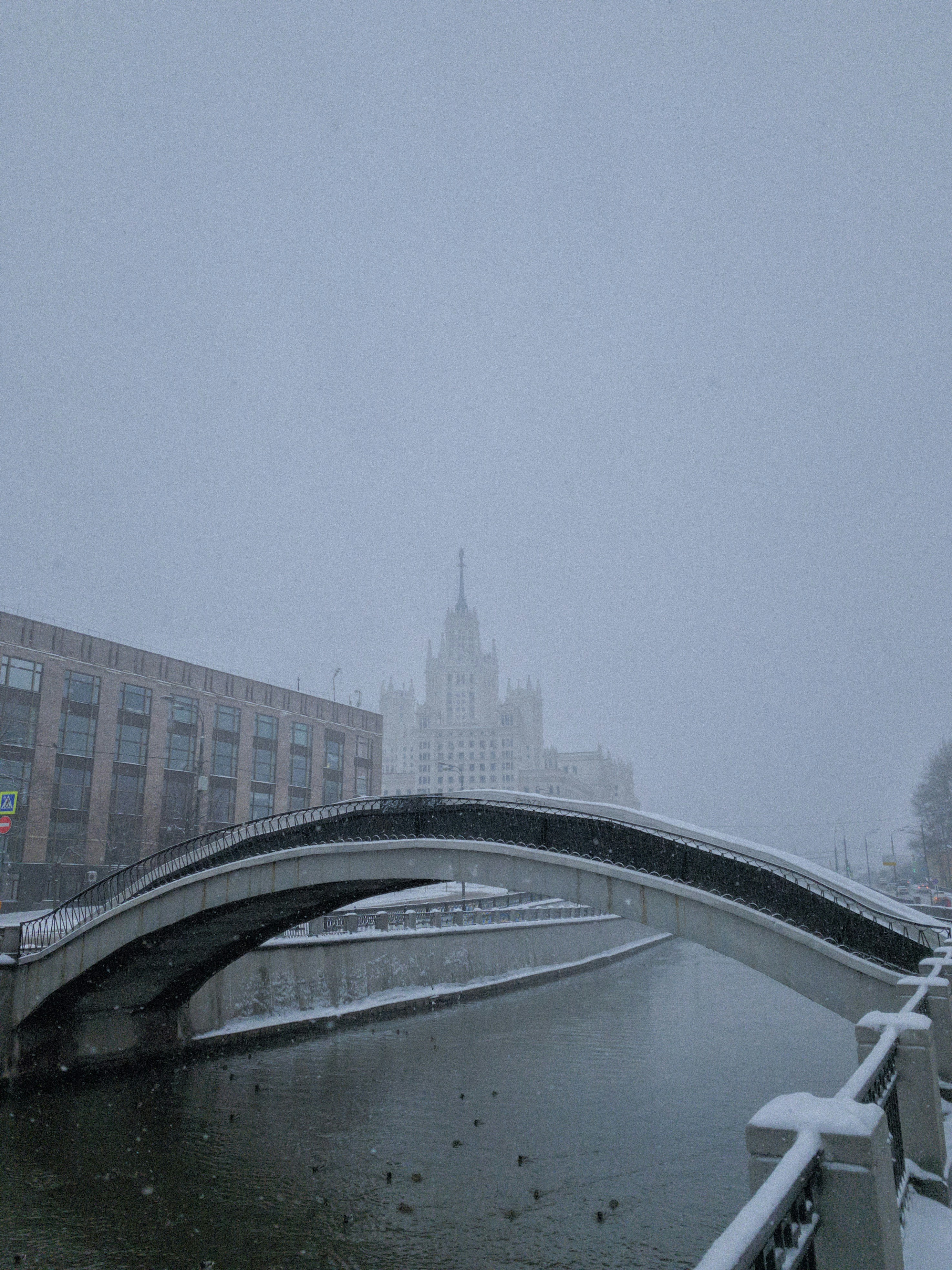 Snowbound City Arc: A Bridge Framed by Blurred Spires