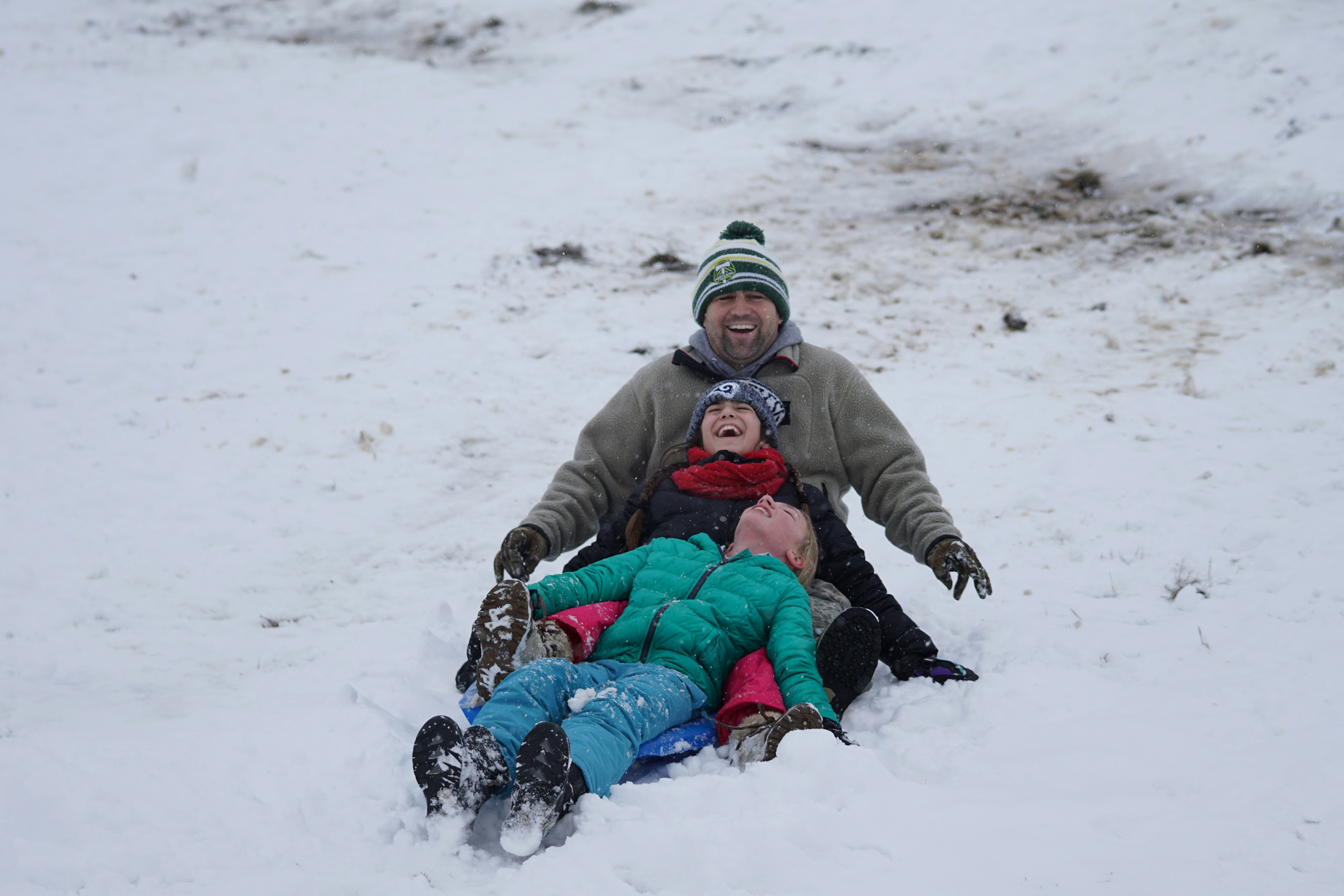 Man and 2 kids sledding on slope photo – Free Human Image on Unsplash