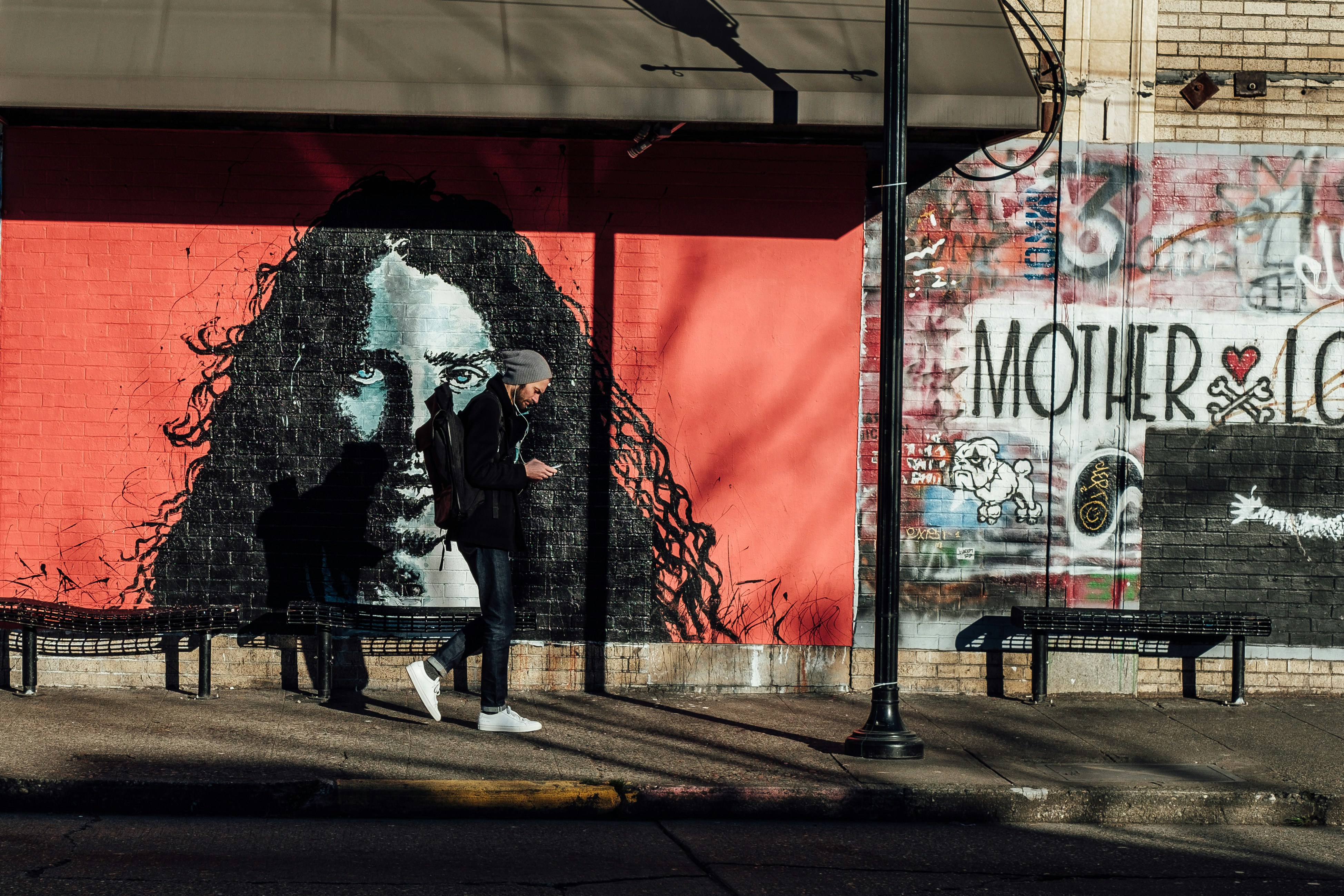 Street Portrait: A Runner Pauses Before a Mona-like Mural