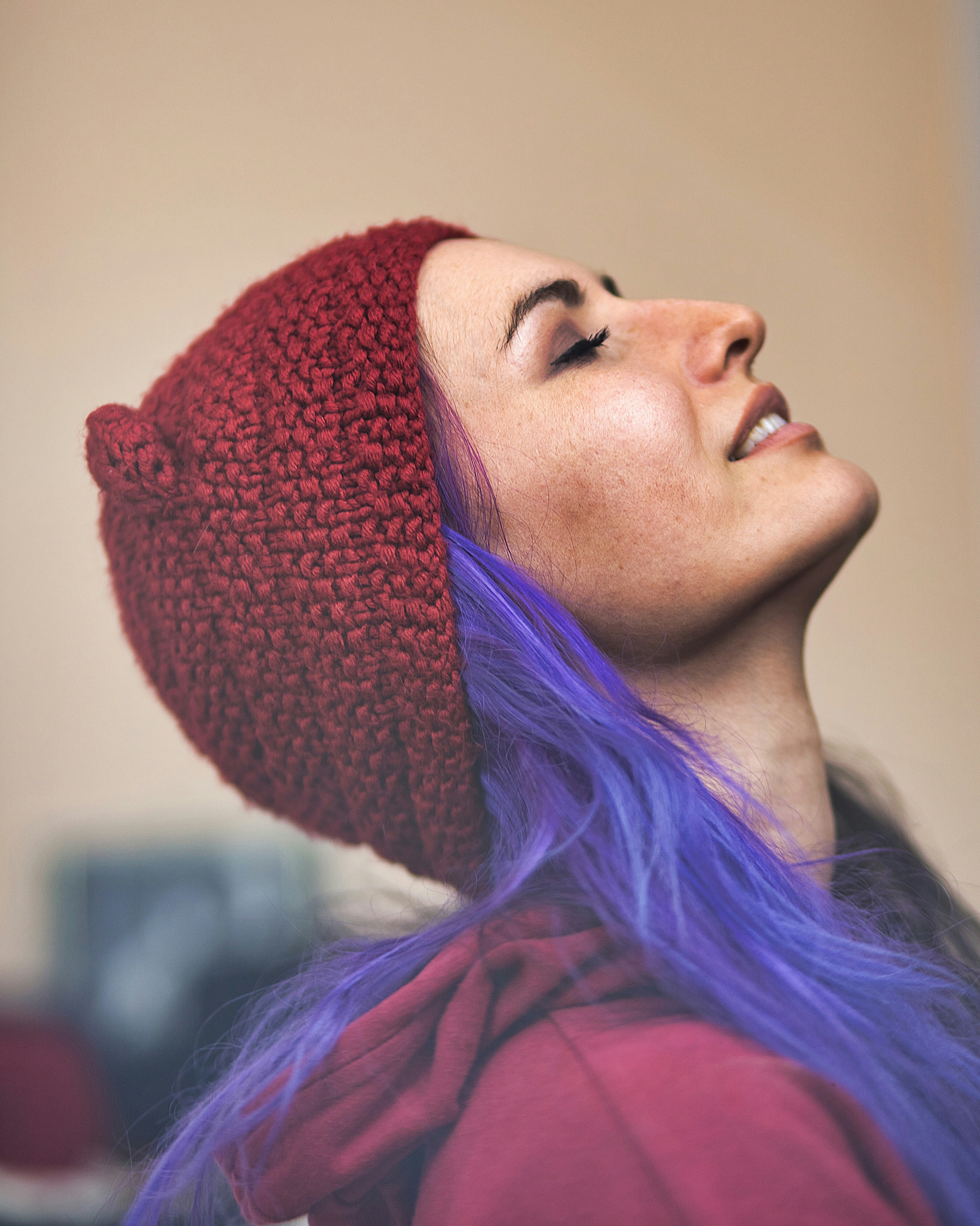 Crimson Knit and Violet Locks: Portrait of a Head-Tilt Reverie