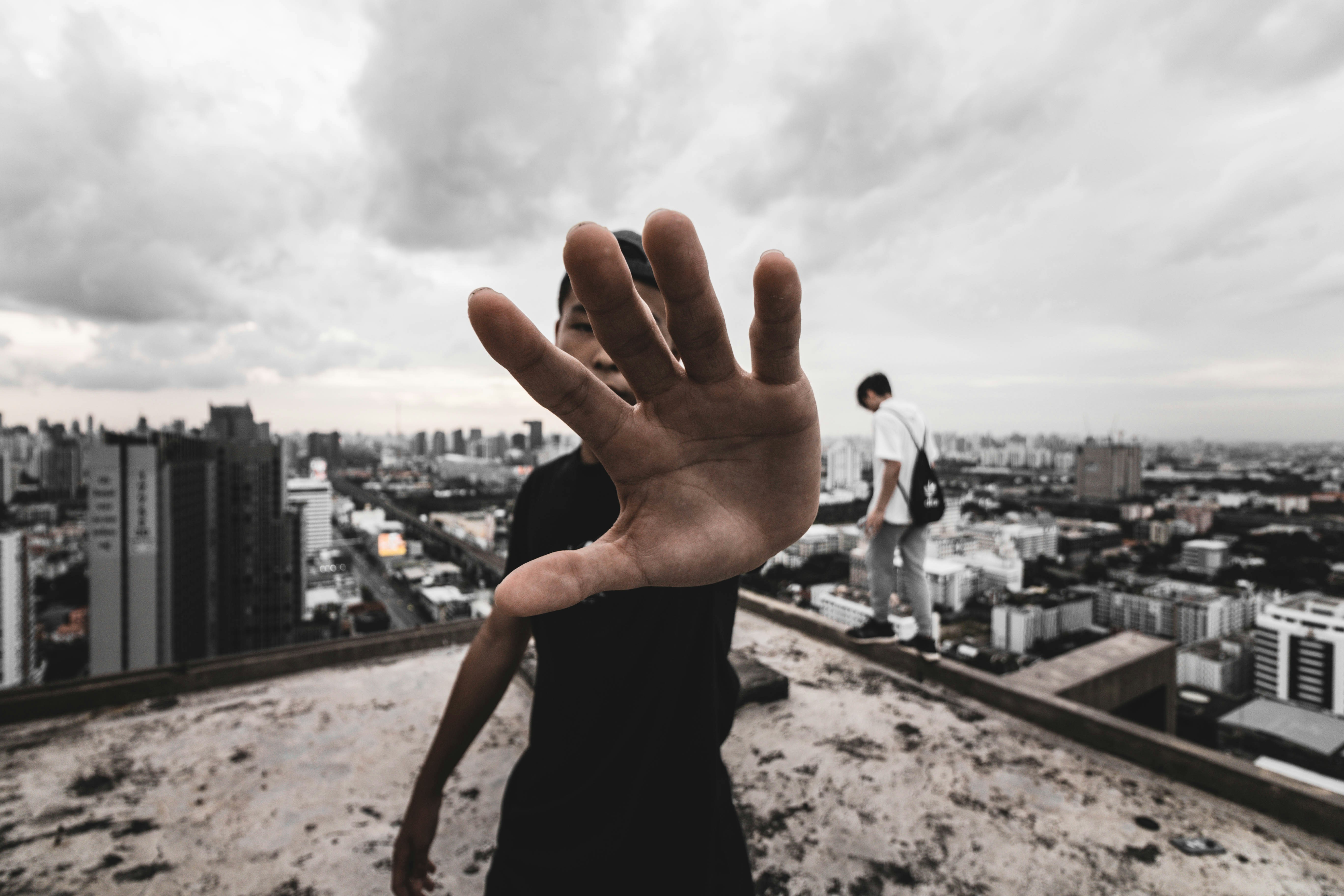 Man standing while raising left hand photo – Free Grey Image on Unsplash