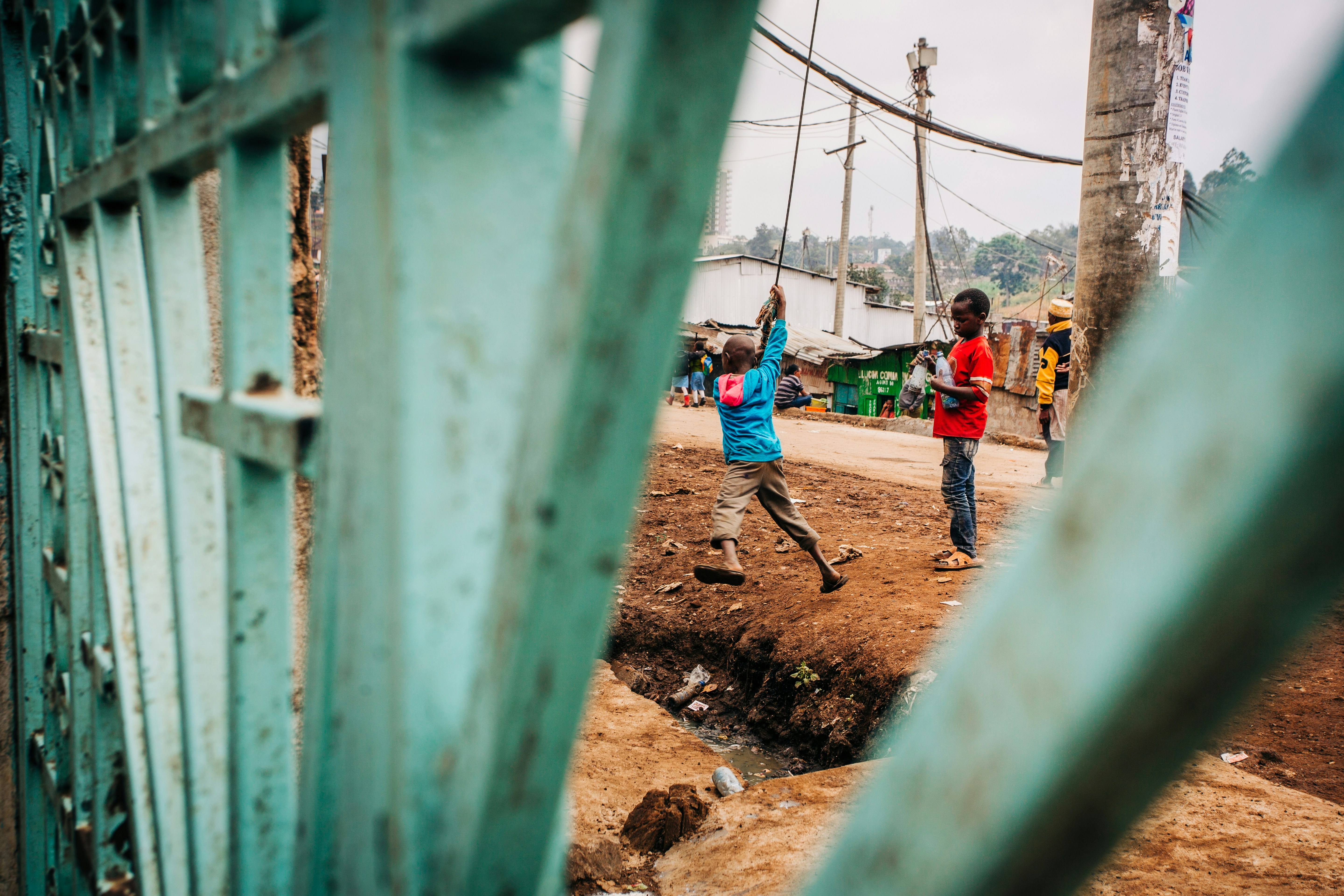 kids playing on cable by gate during daytimebennett tobias