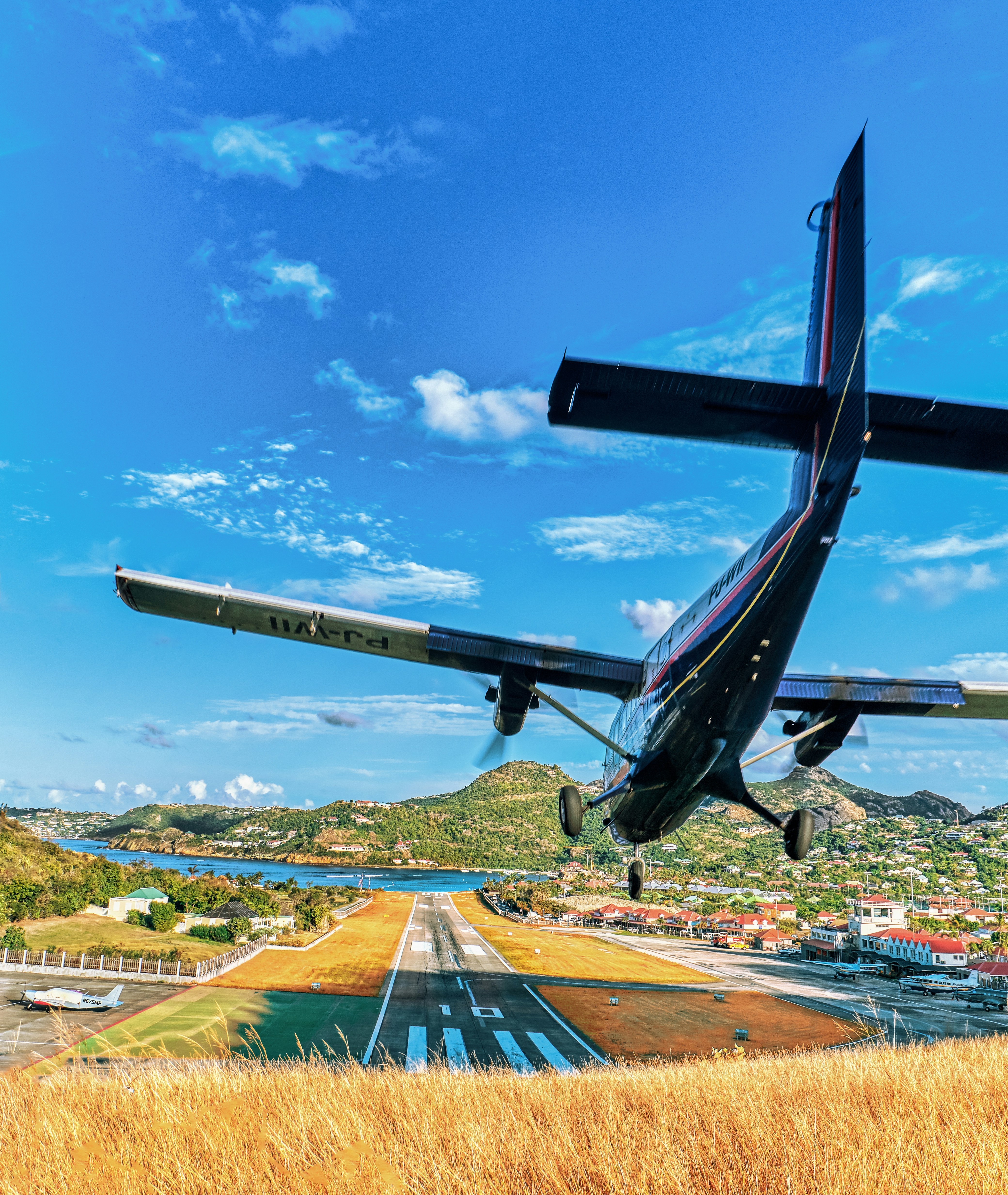 Jet Exactly Above Runway: A Takeoff Against Coastal Hills