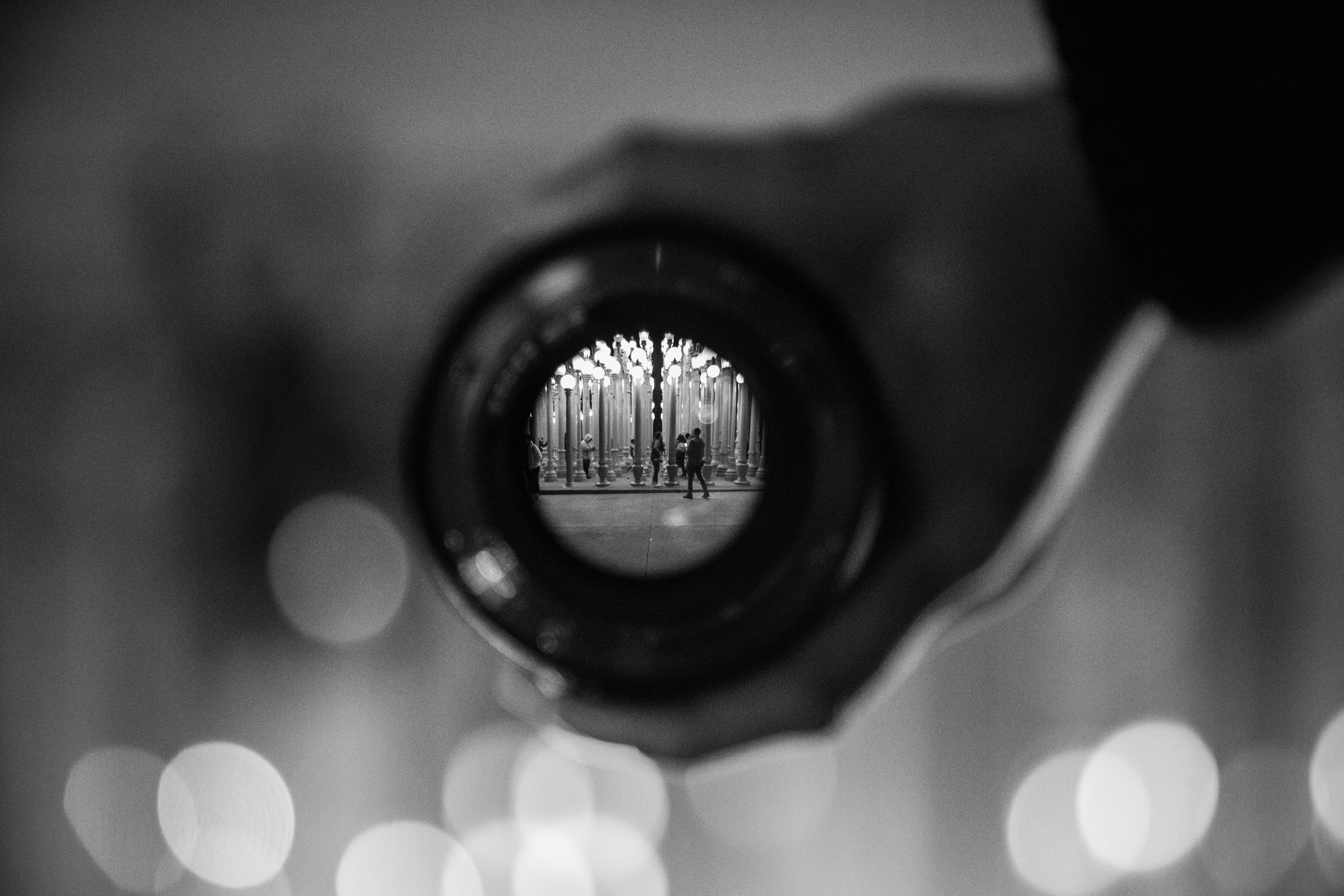 Circle of Silence: Silhouettes Trek Through a Forest Framed by a Lens