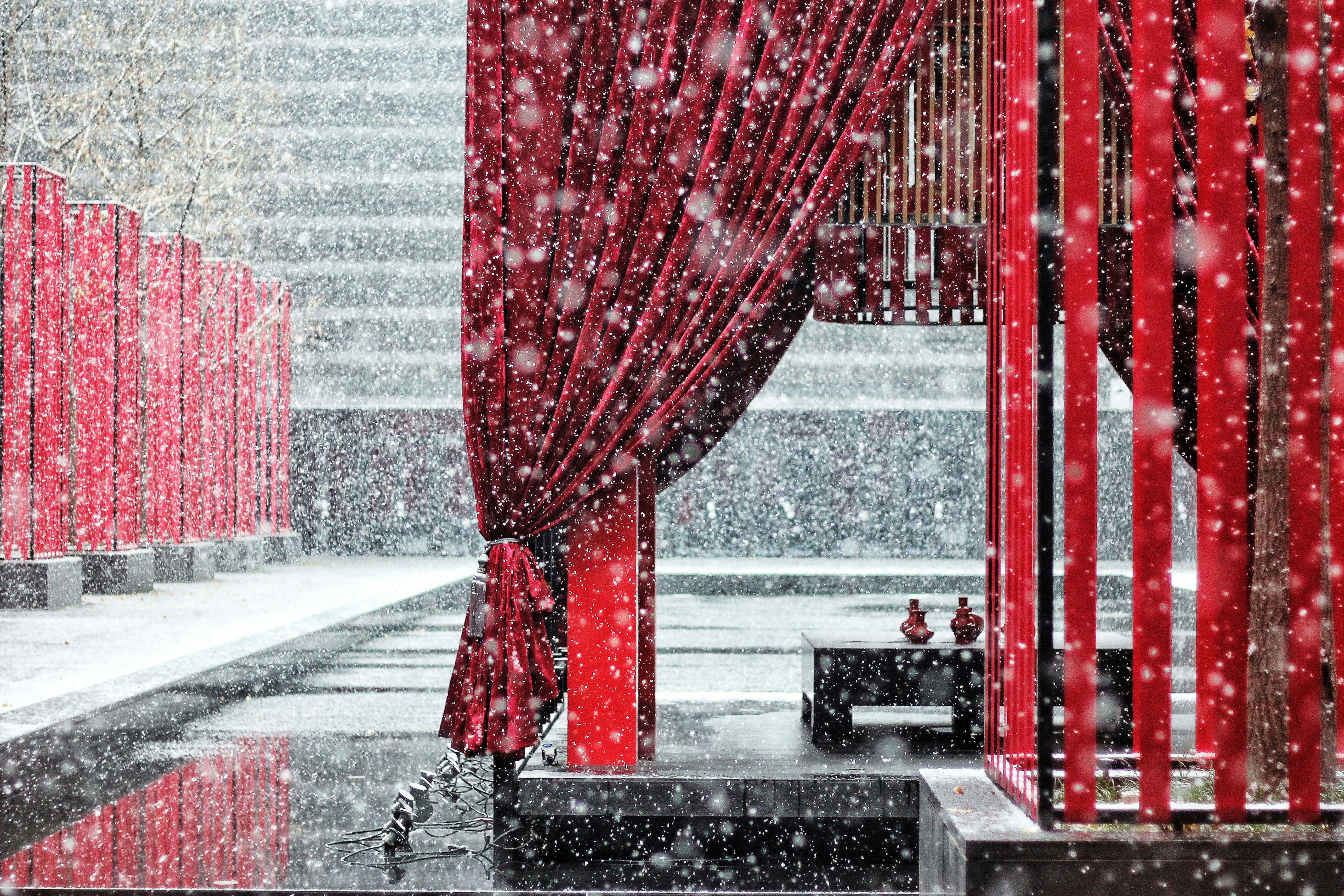 Crimson Canopy: Snowflakes over a Red Pavilion