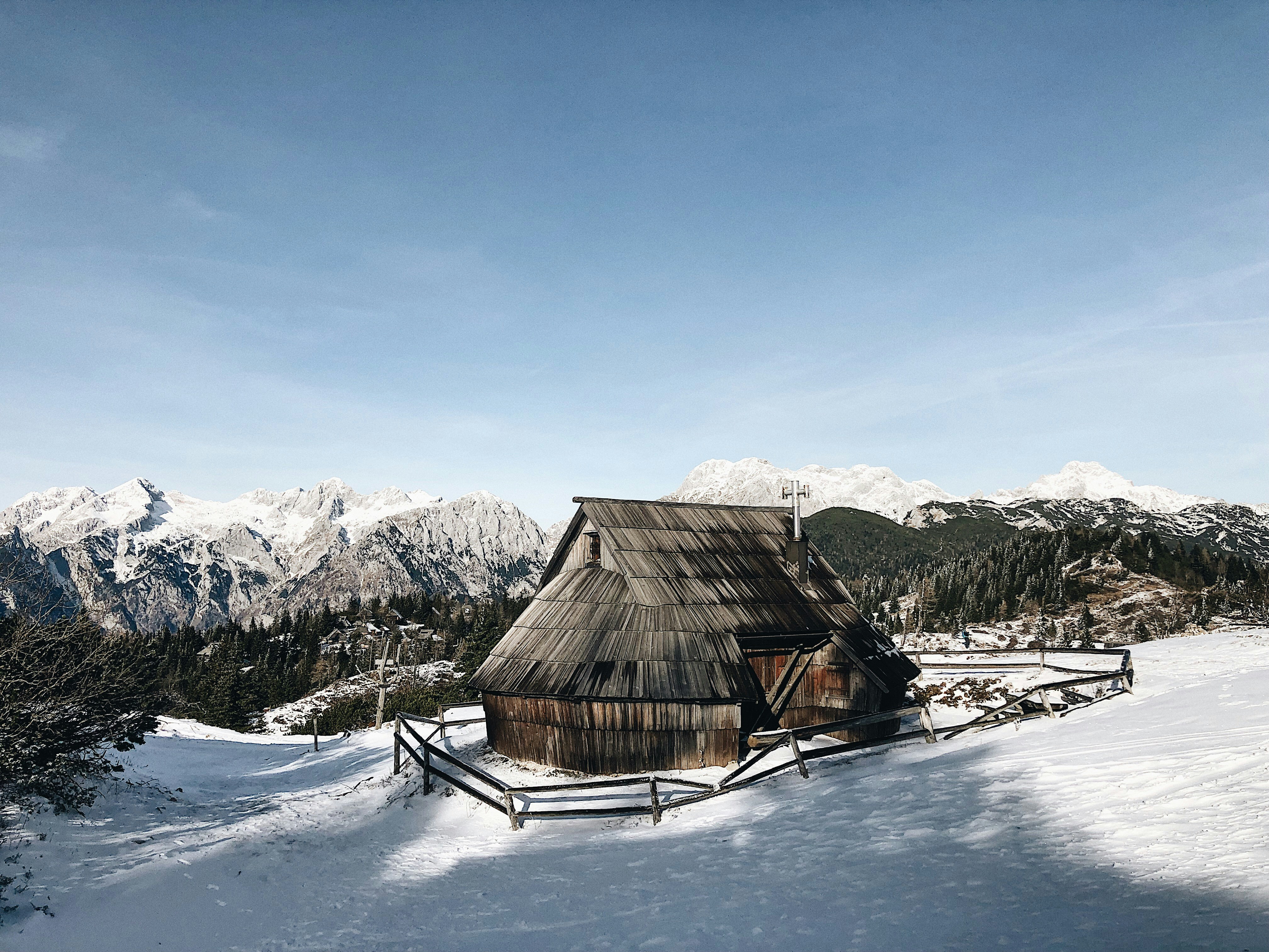 Snowbound A-frame Refuge Amid a Snow-Capped Alpine Panorama
