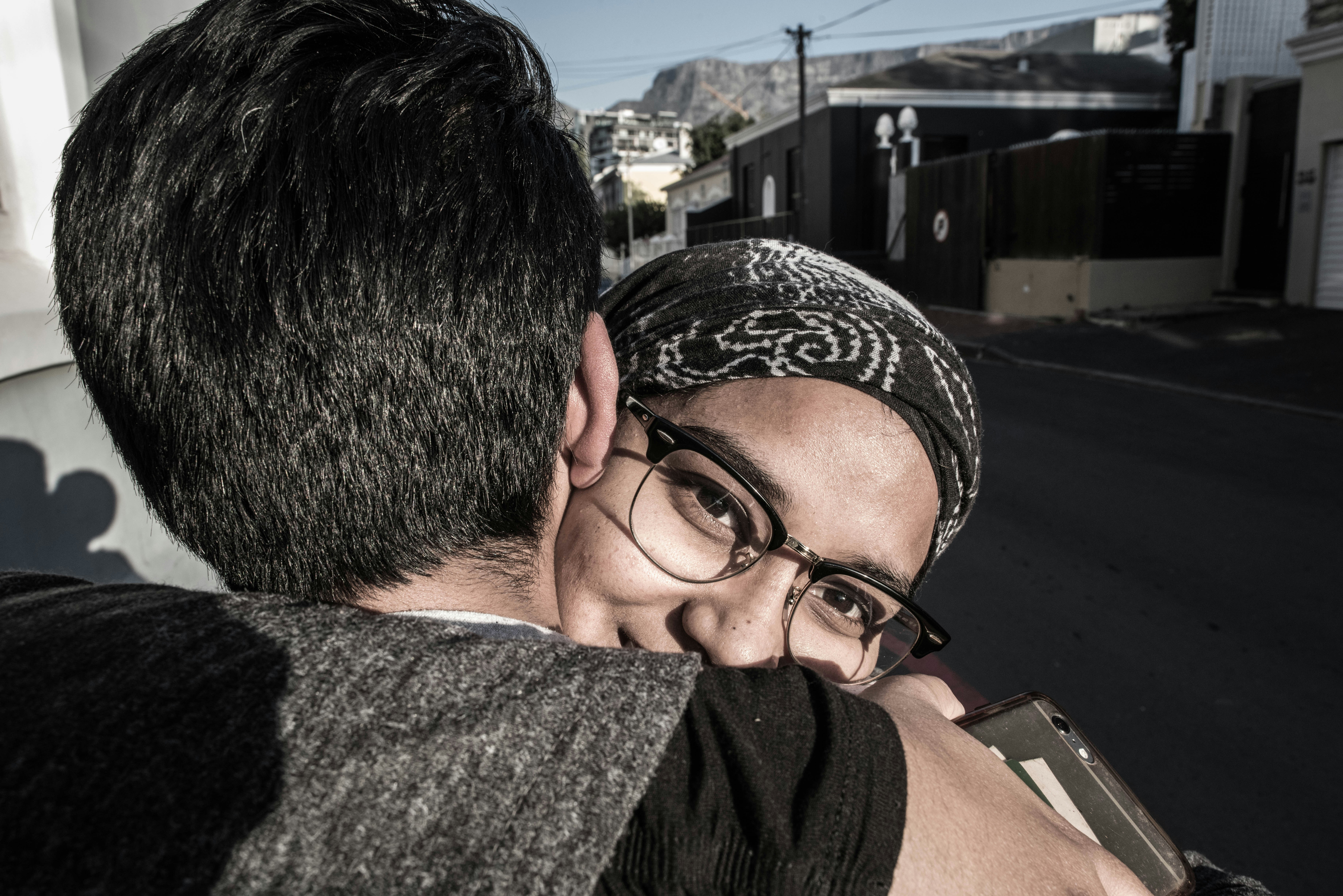 Street Embrace: A Quiet Moment of Joy in Sunlit Light