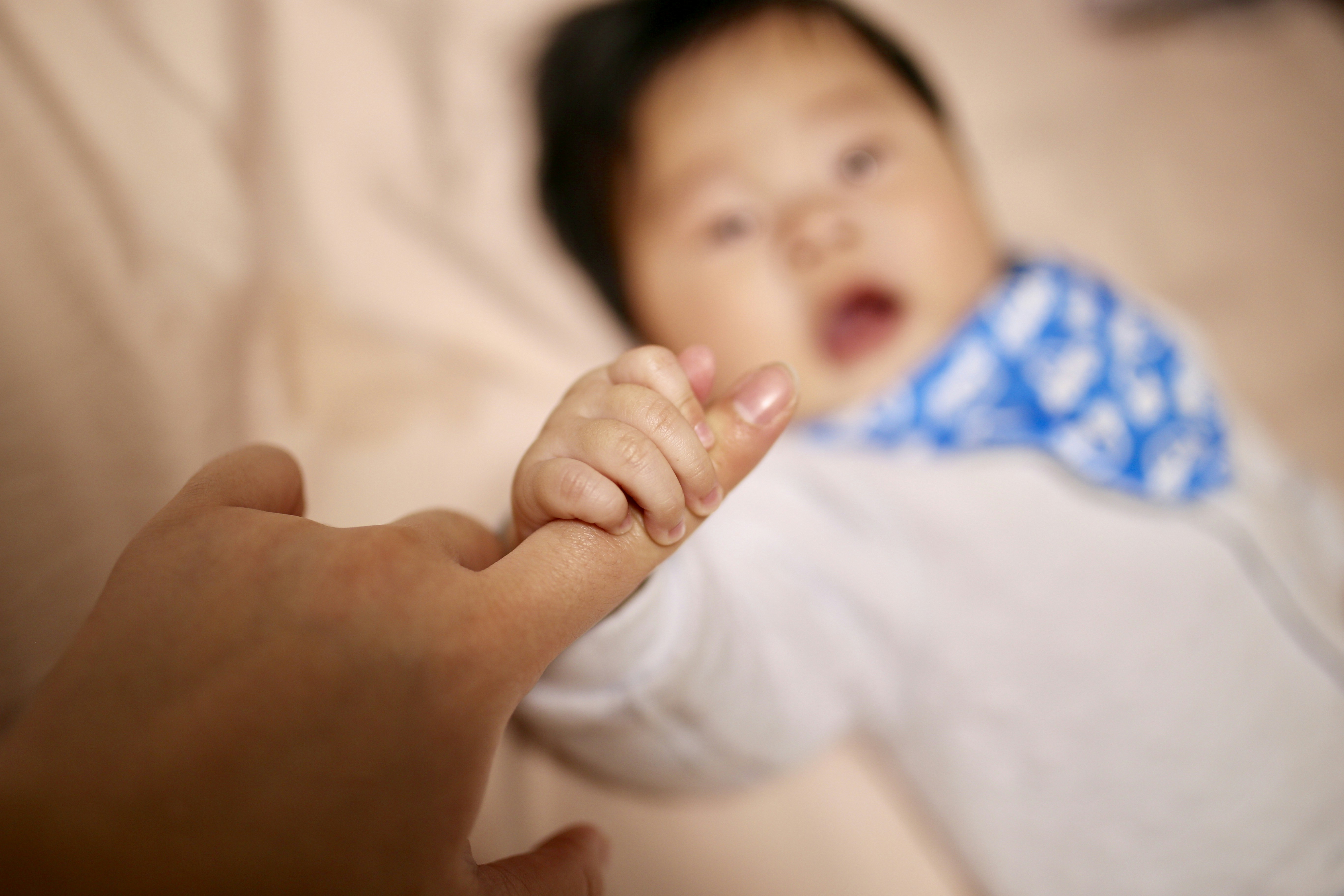 Selective focus photography of baby holding index finger photo – Free ...