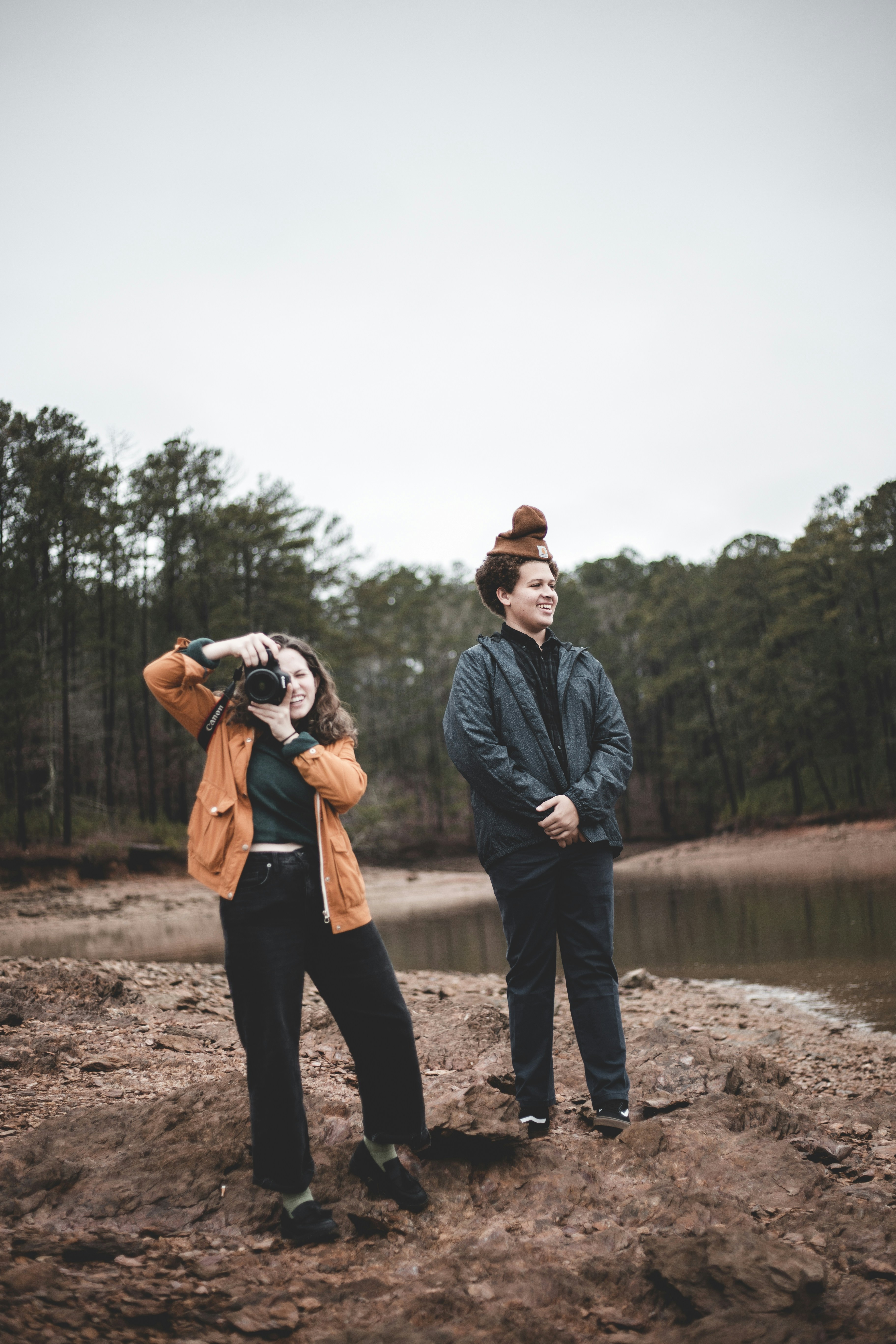 Two Friends by the Lake: A Candid Camera Moment in Autumn Light