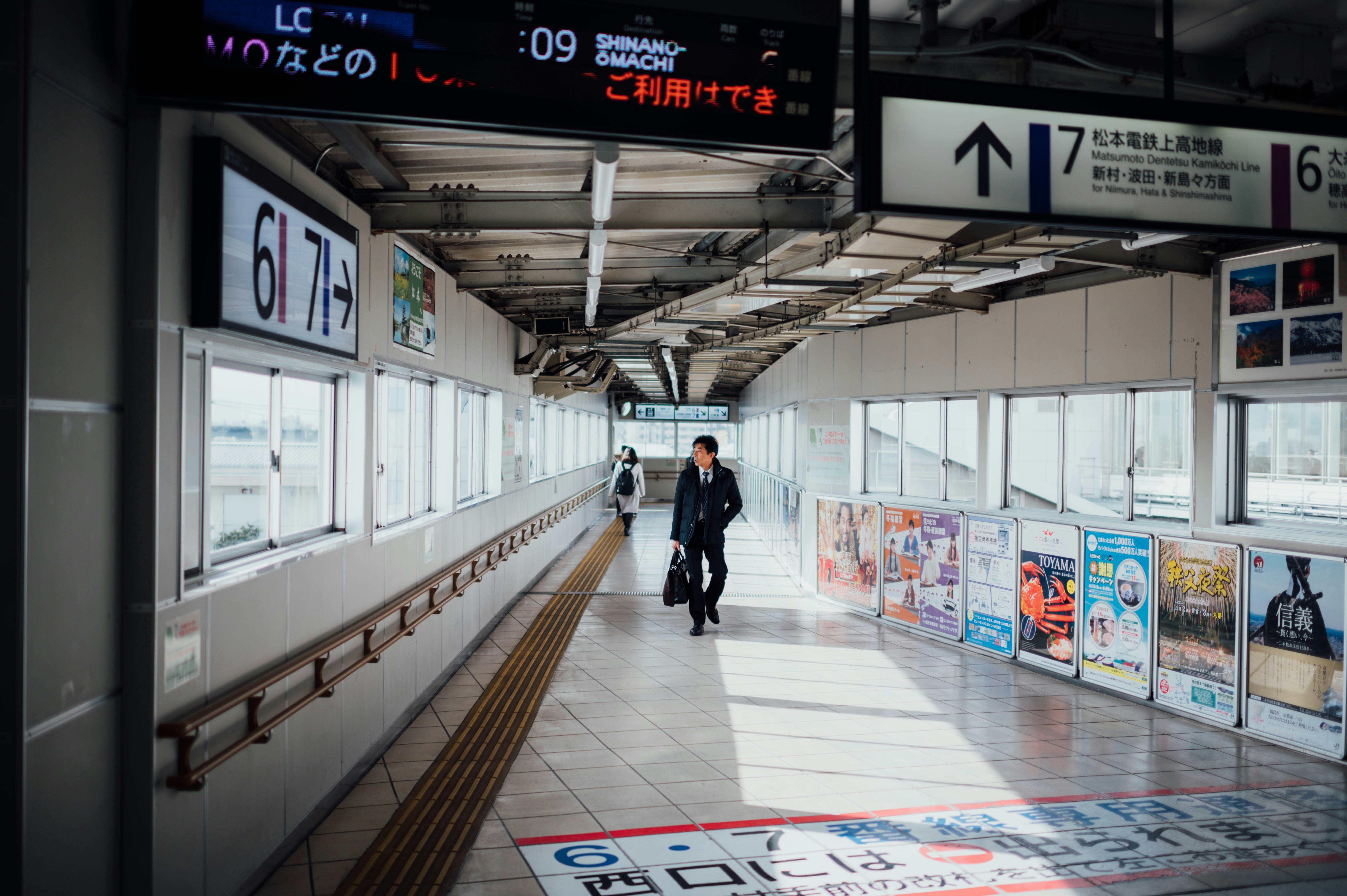 Man walking inside concrete building photo – Free Grey Image on Unsplash