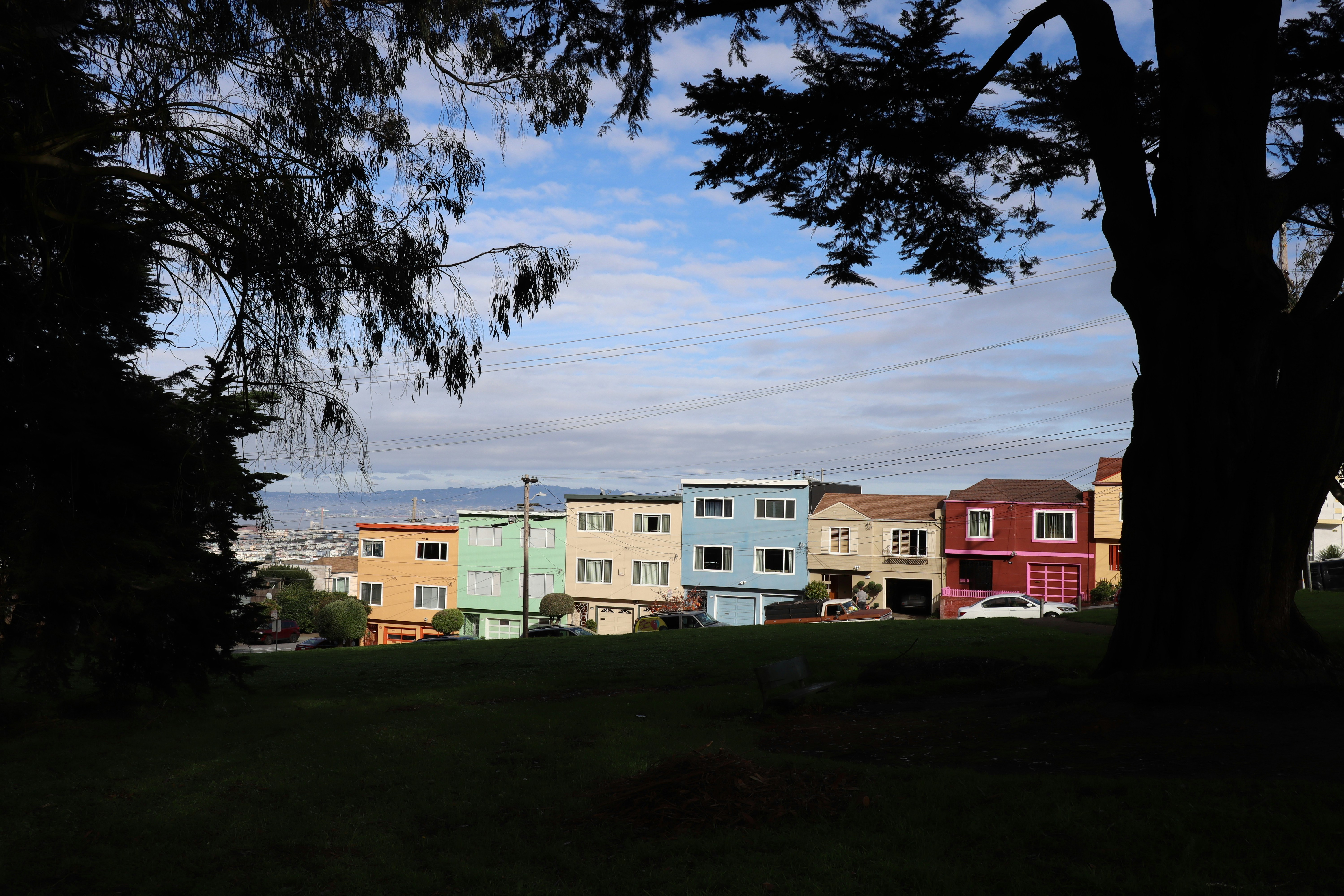 Assorted-color concrete buildings near trees during daytime photo ...