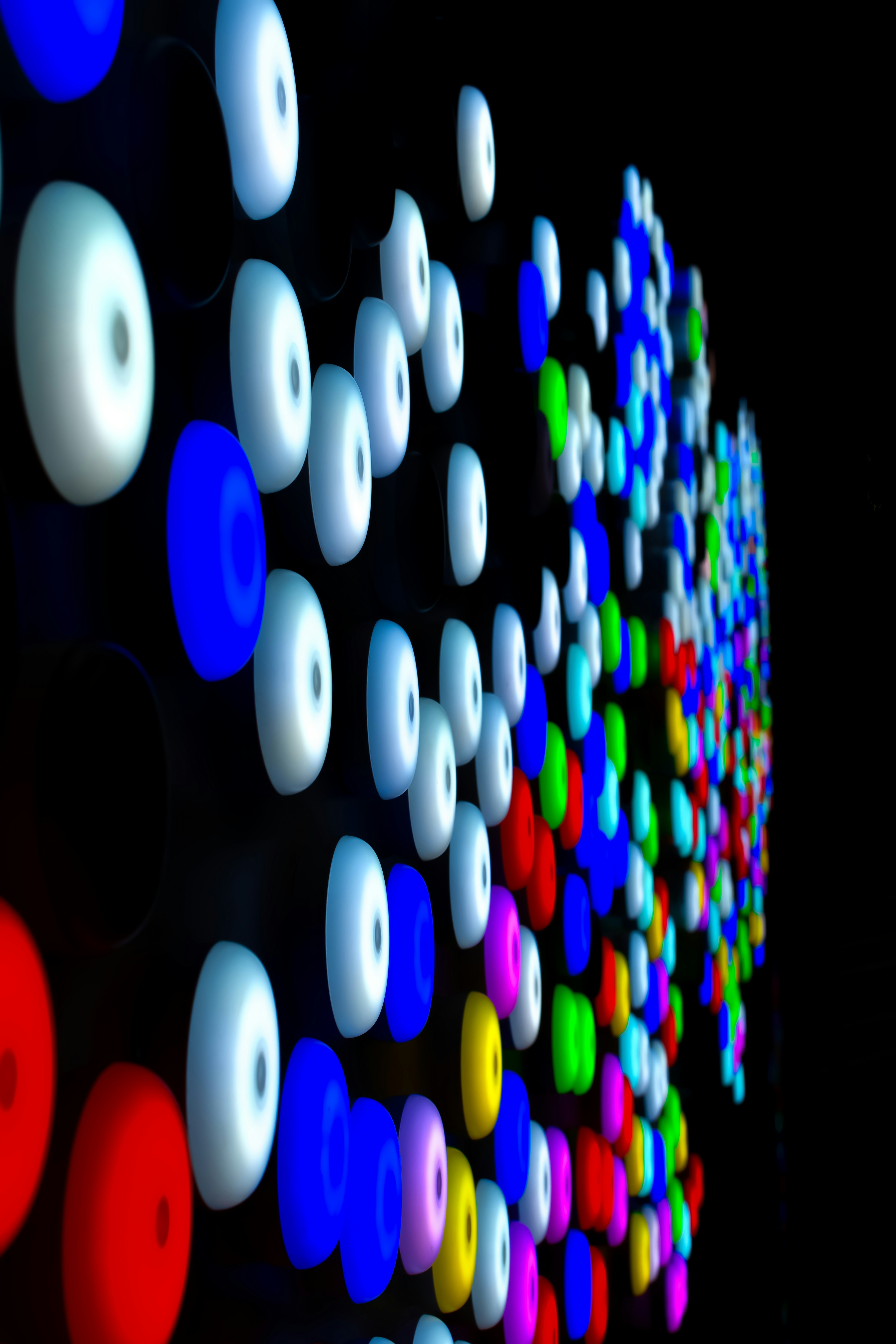 Ribbon of Neon Orbs: A Curved Cascade of Colorful Bokeh