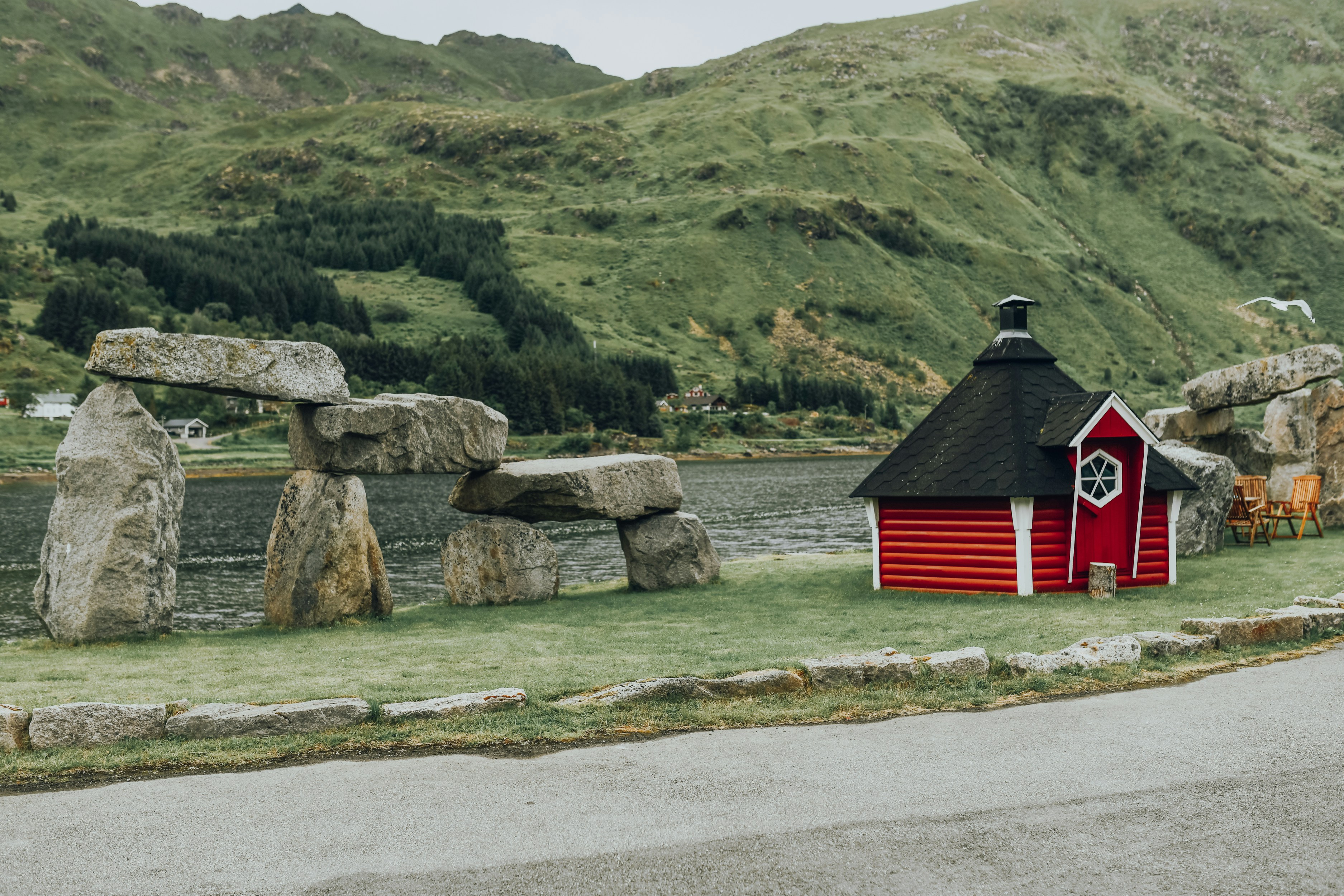 Red and black wooden house beside rock formation photo – Free Building ...