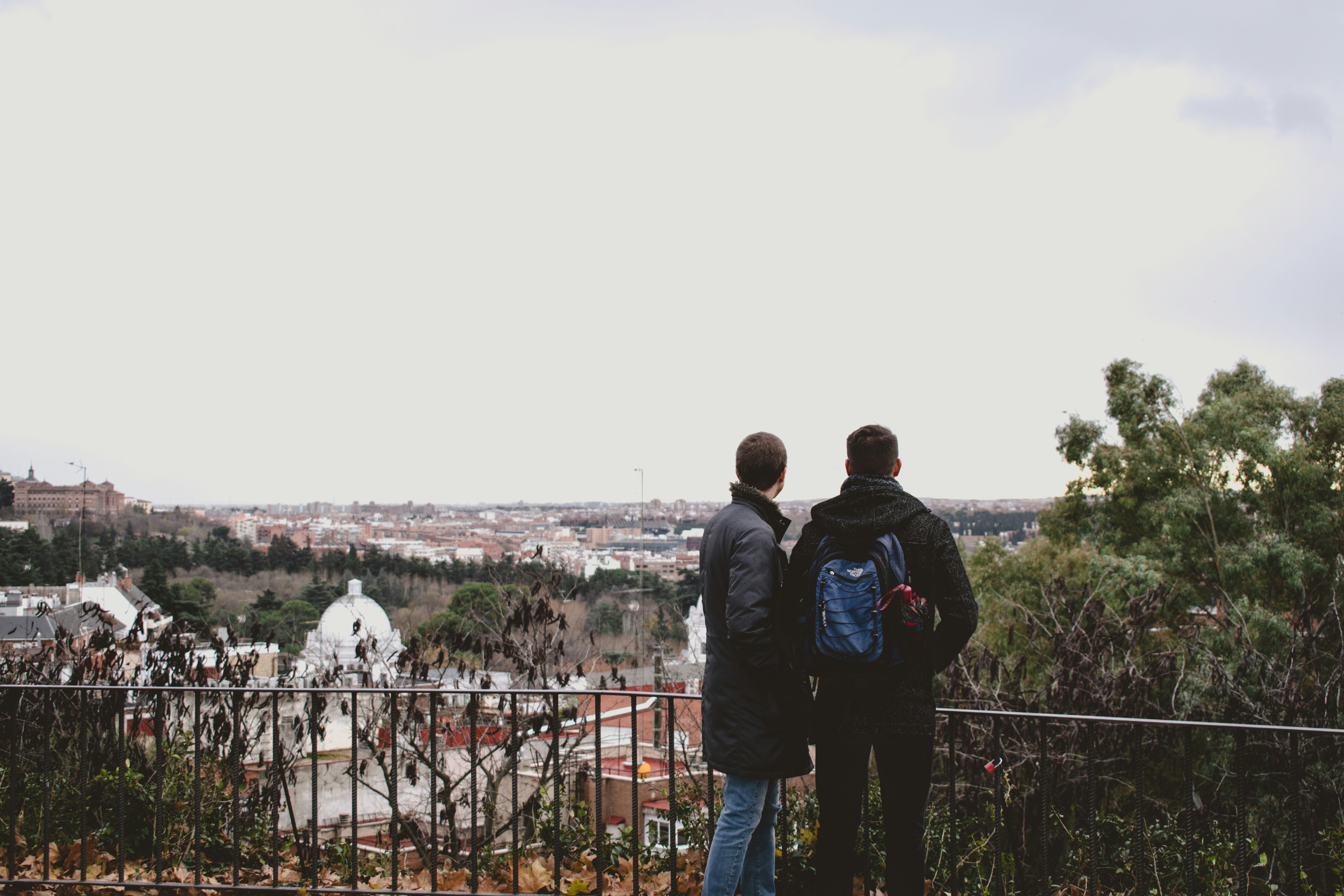 Edge of the City Lookout: Two Figures at the Rail Overlooking the Sprawl