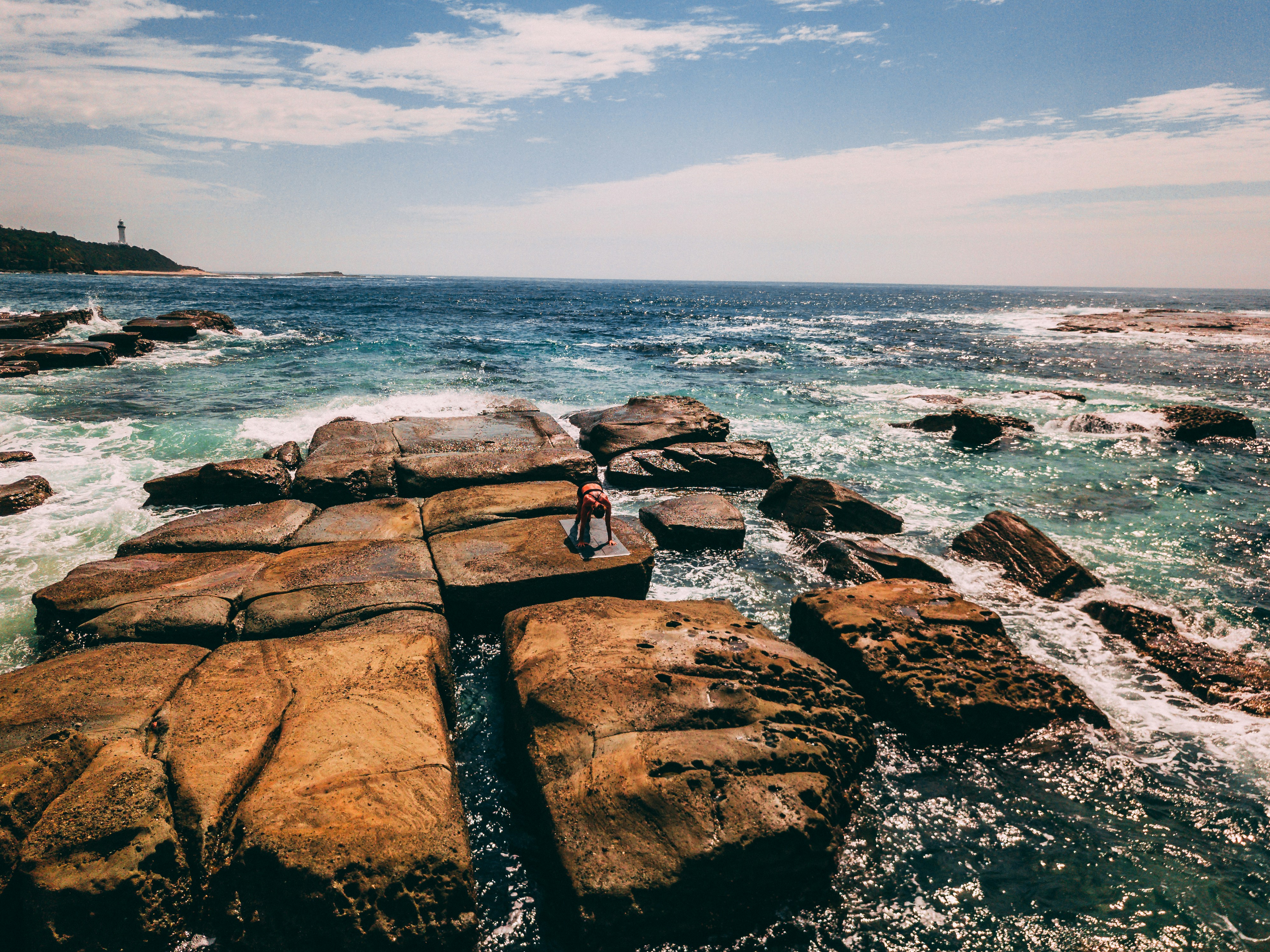 ocean waves crashing on brown rock formation