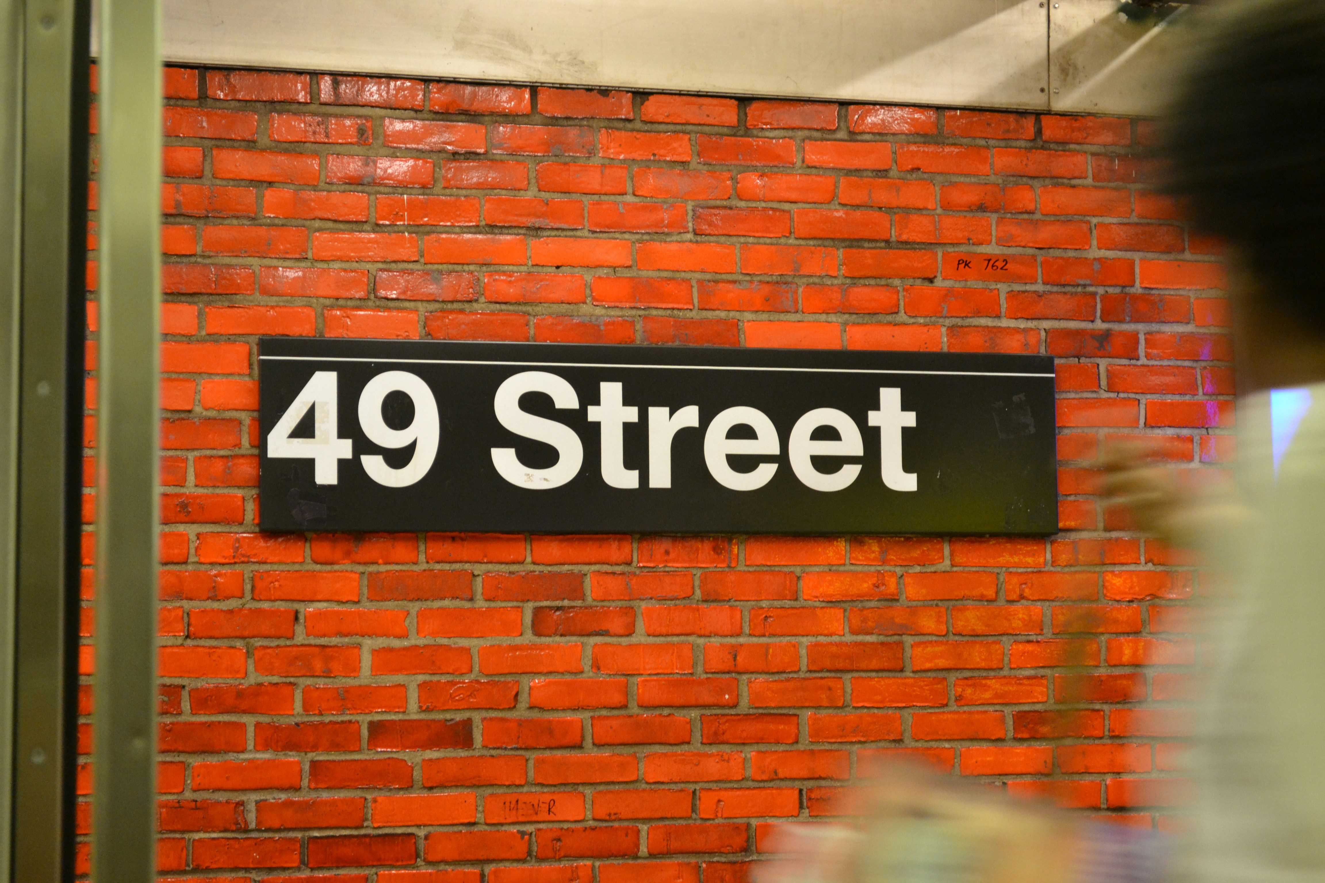 Black and white 49 Street signage on brown bricked wall photo – Free ...