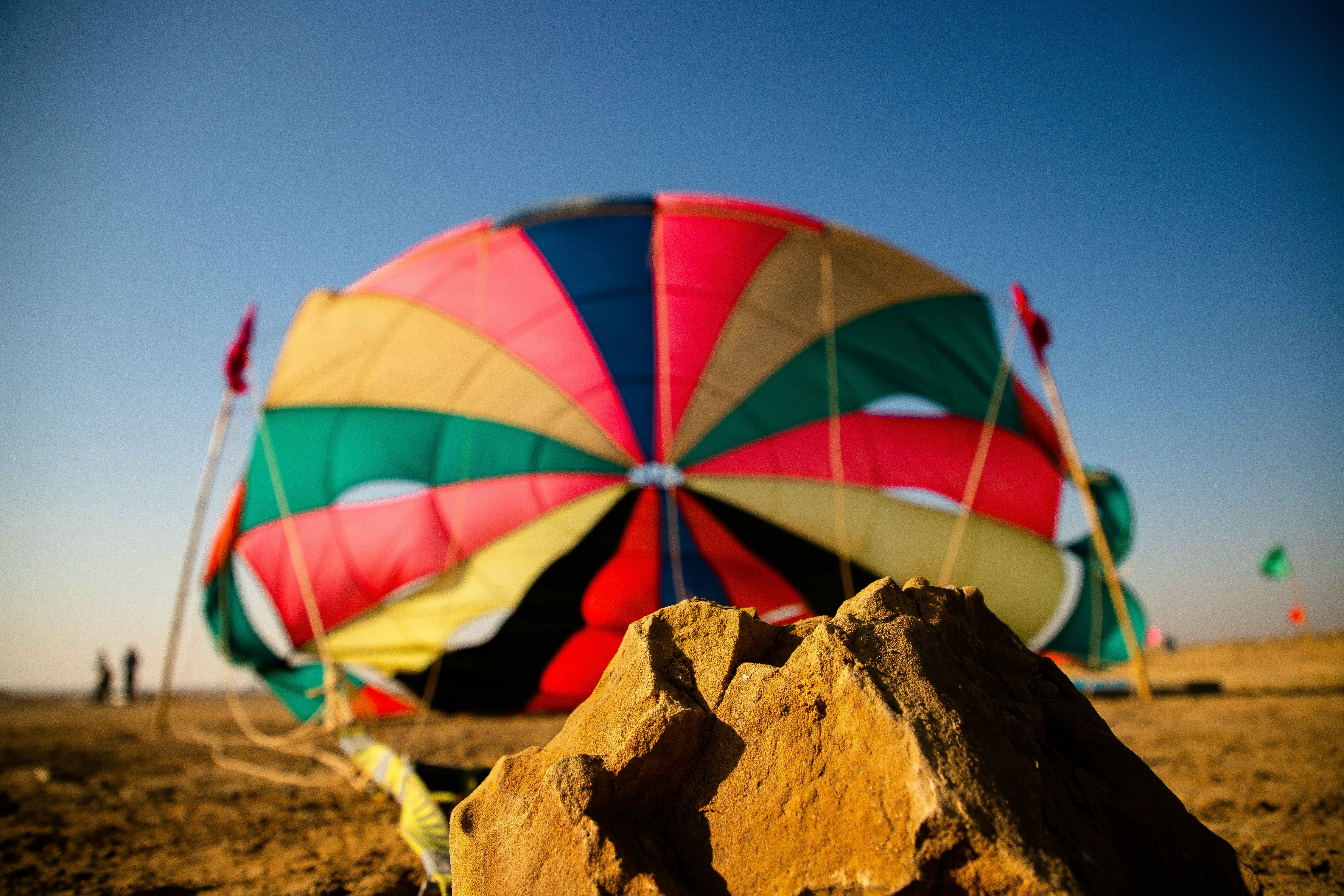 Colorful Parachute Burst on a Desert Plain