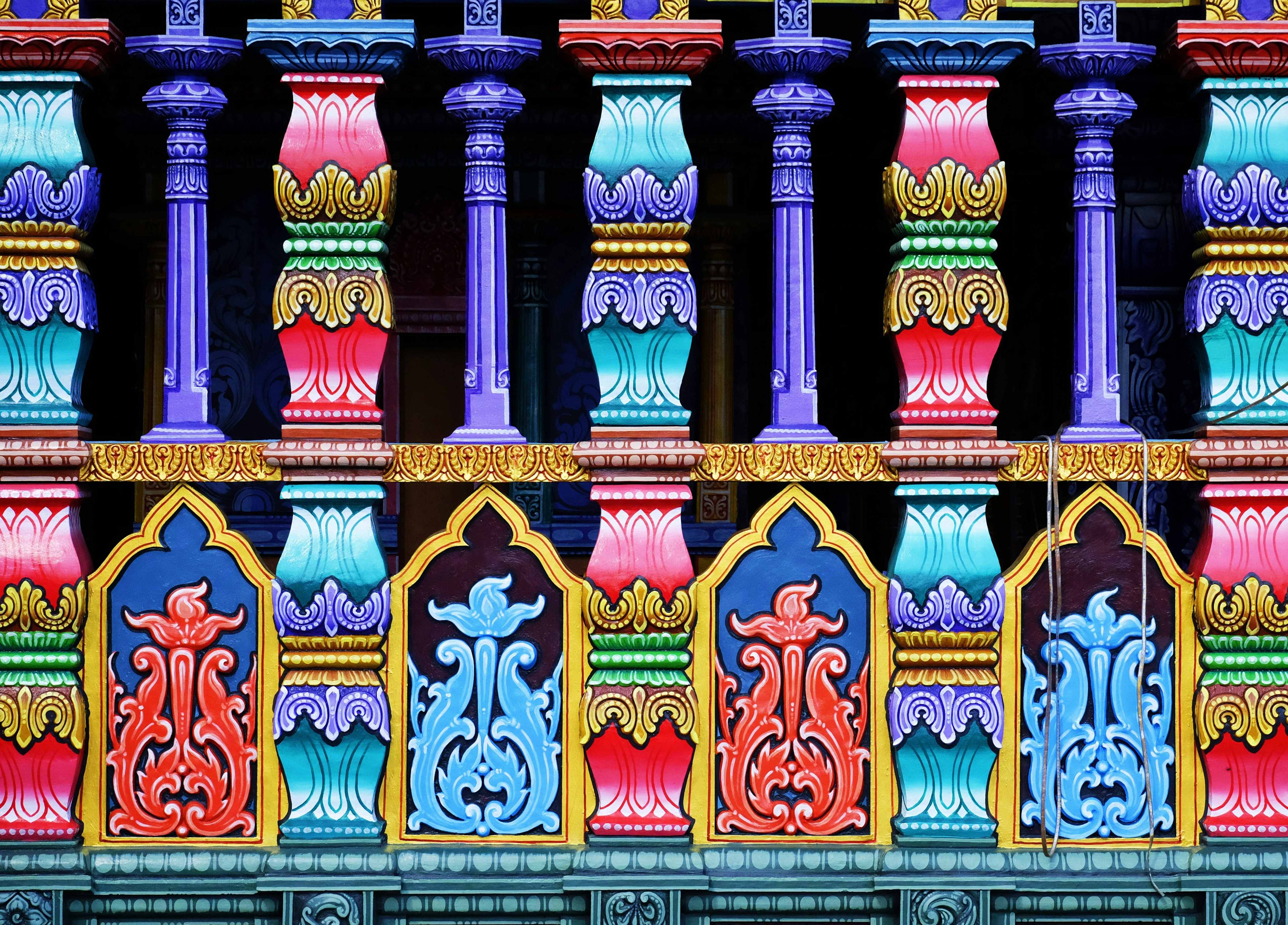 Vibrant Carved Columns: A Row of Colorful Architectural Niches