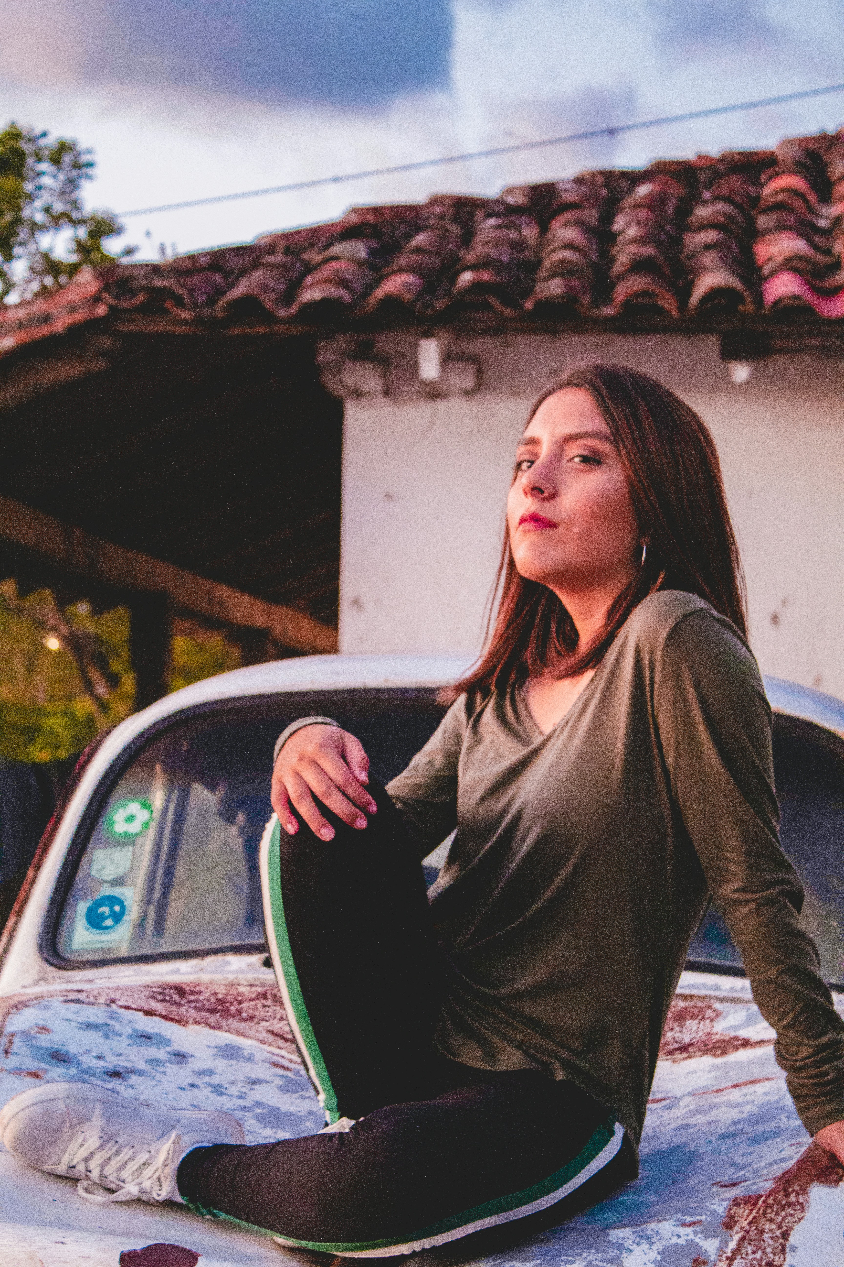 Casual Confidence: A Woman Poses on a Weathered Truck