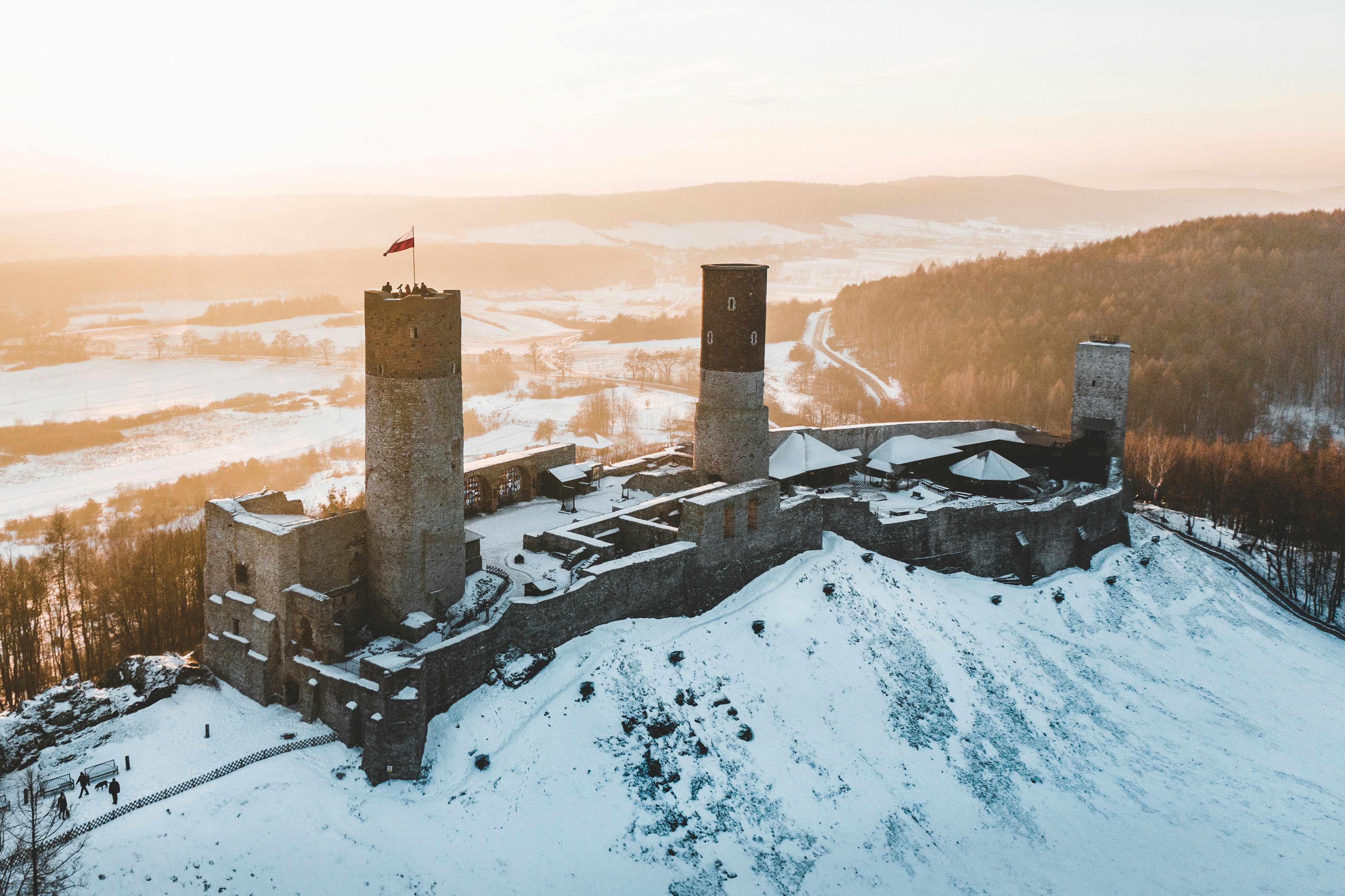 aerial view of gray concrete castle surrounded with snow
