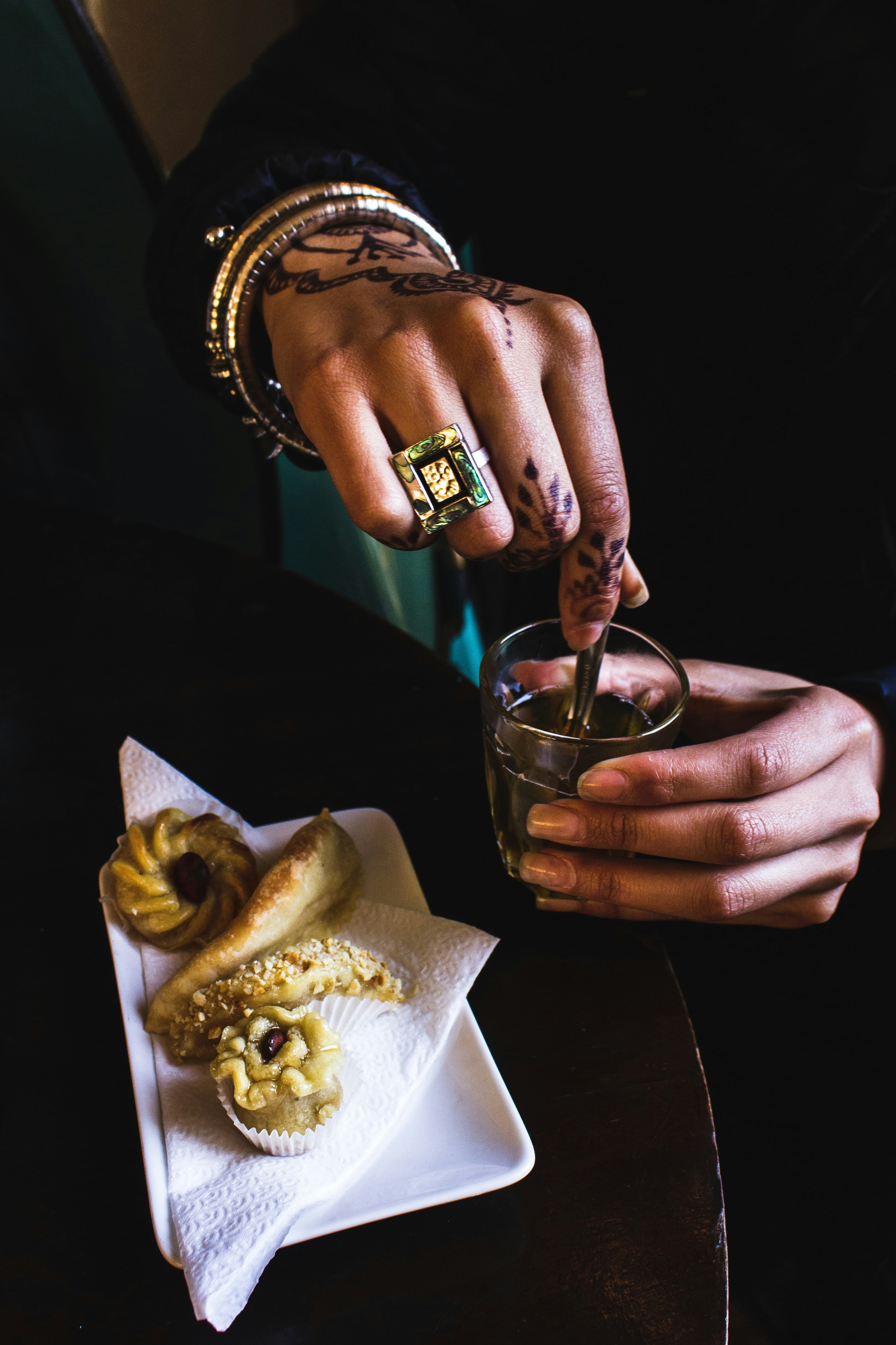 Ink and Glass: A Tattooed Hand Reaches for a Drink