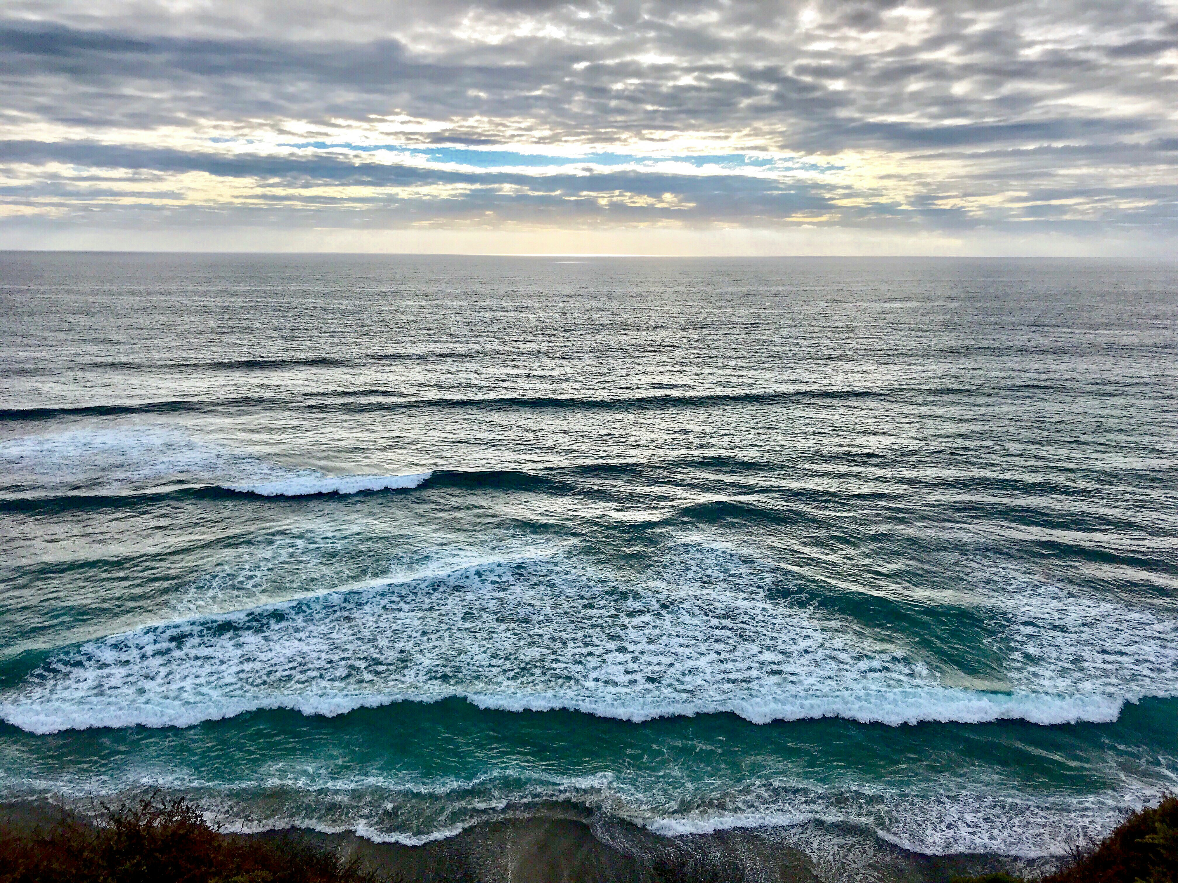 Turquoise Crest at Dusk: Foam Edges the Quiet Horizon