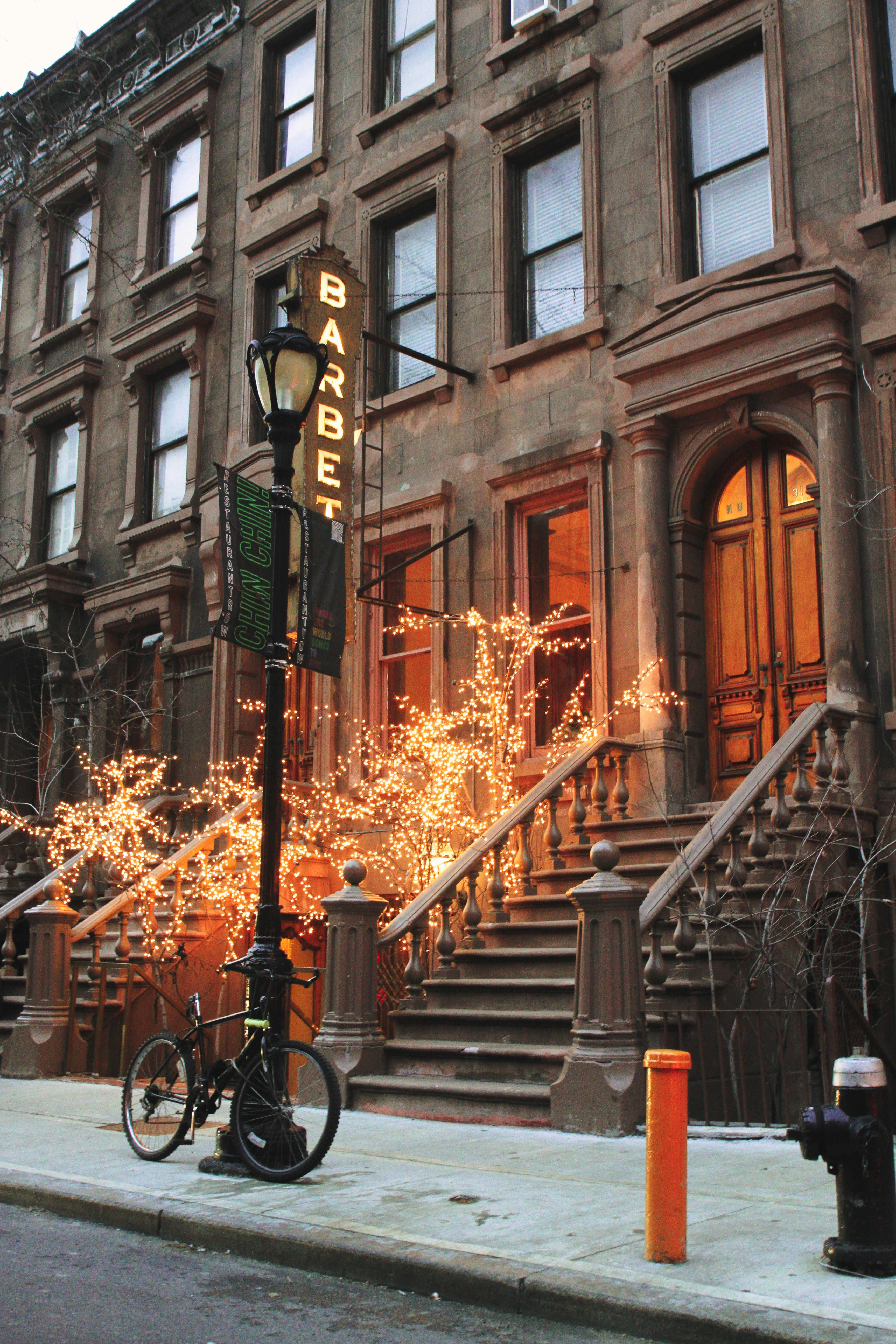 Fairy-Lit Brownstones: Nighttime Staircase and Bicycle Portrait