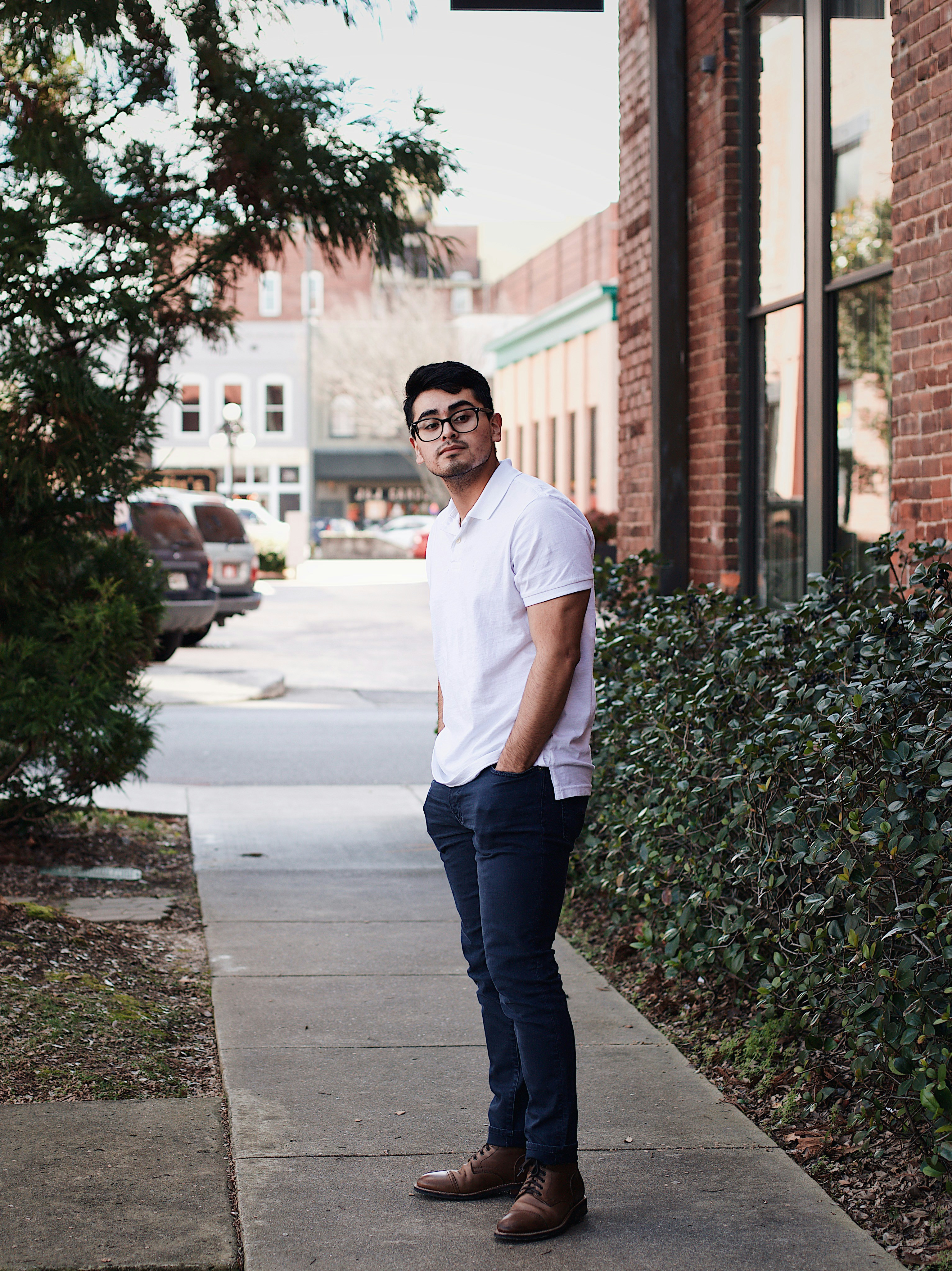 Sidewalk Portrait: Quiet Confidence in a Sunlit City Alley