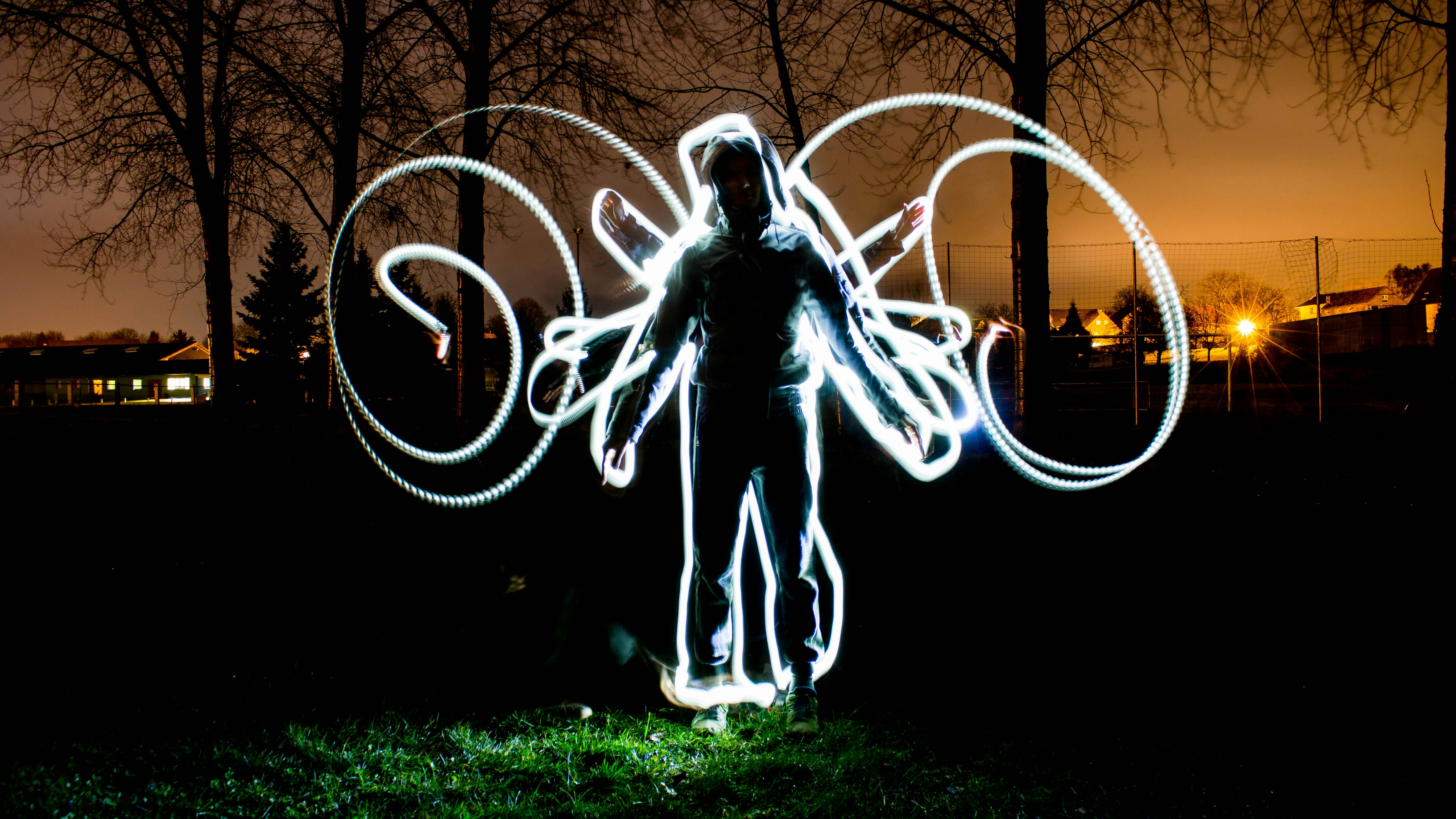 Neon Echoes: Nighttime Light-Painted Figure in the Park