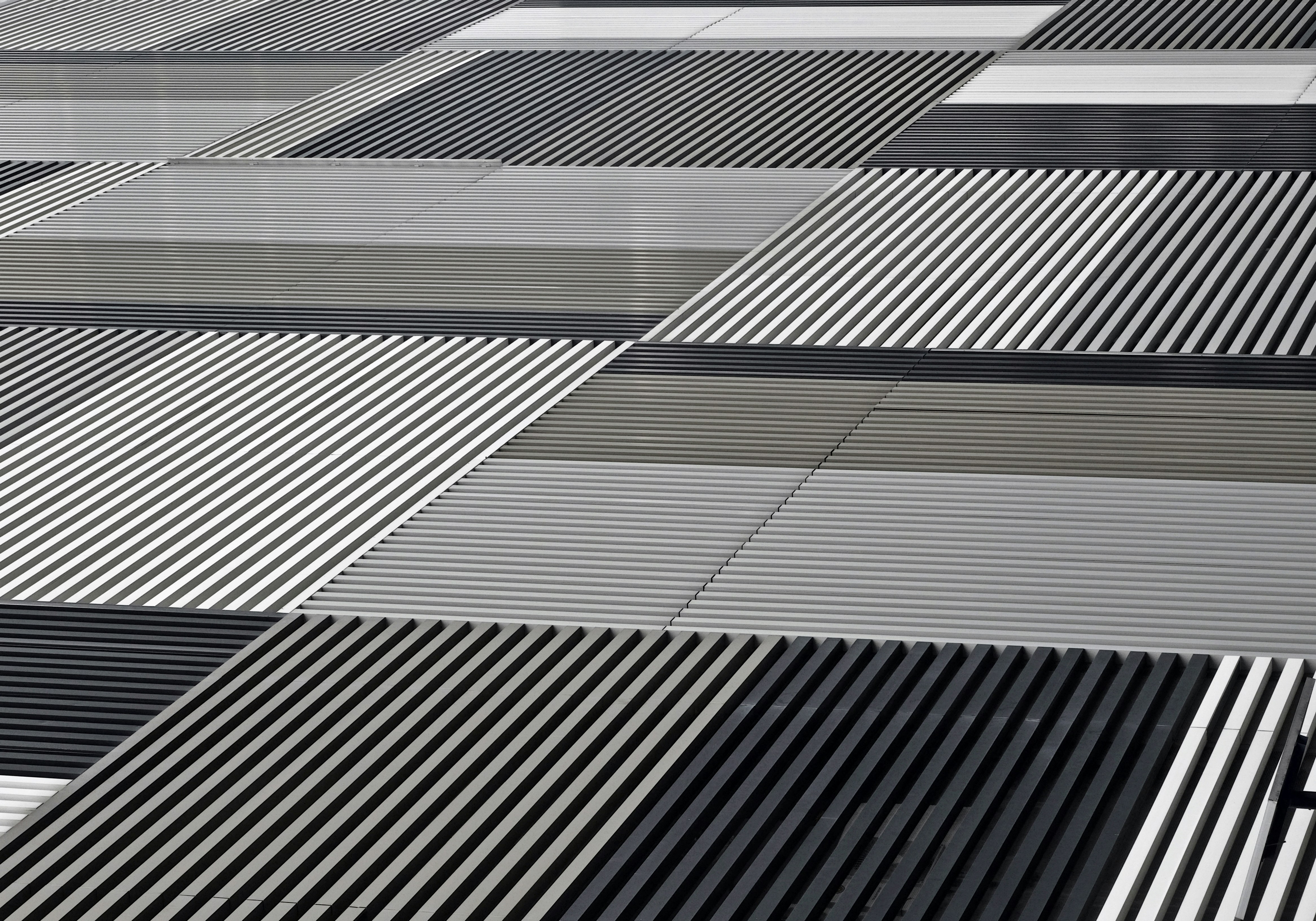 Monochrome Grid: Diagonal Slats Form a Quiet Facade Rhythm