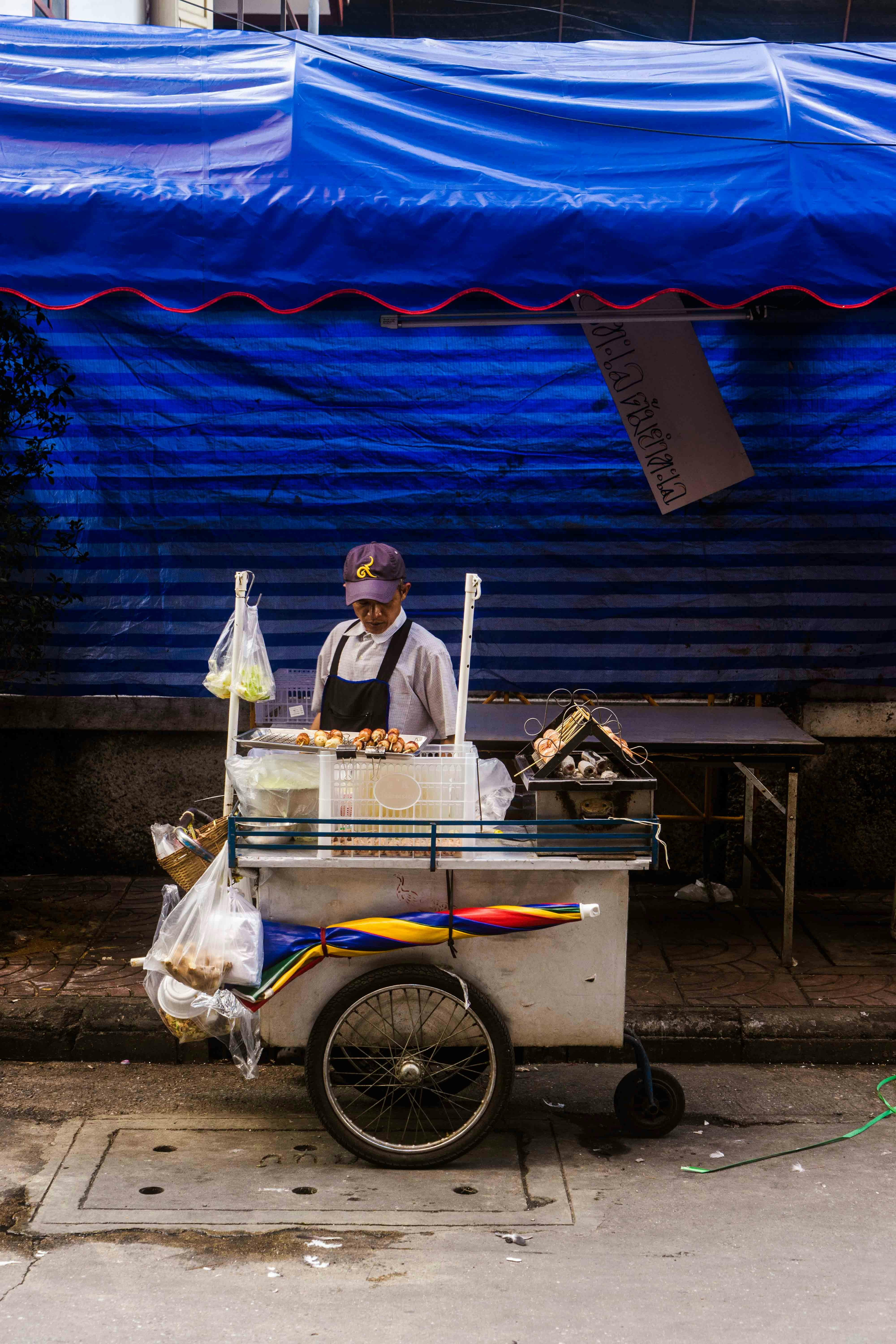 Man standing in front of ice cream stall photo – Free Blue Image on ...