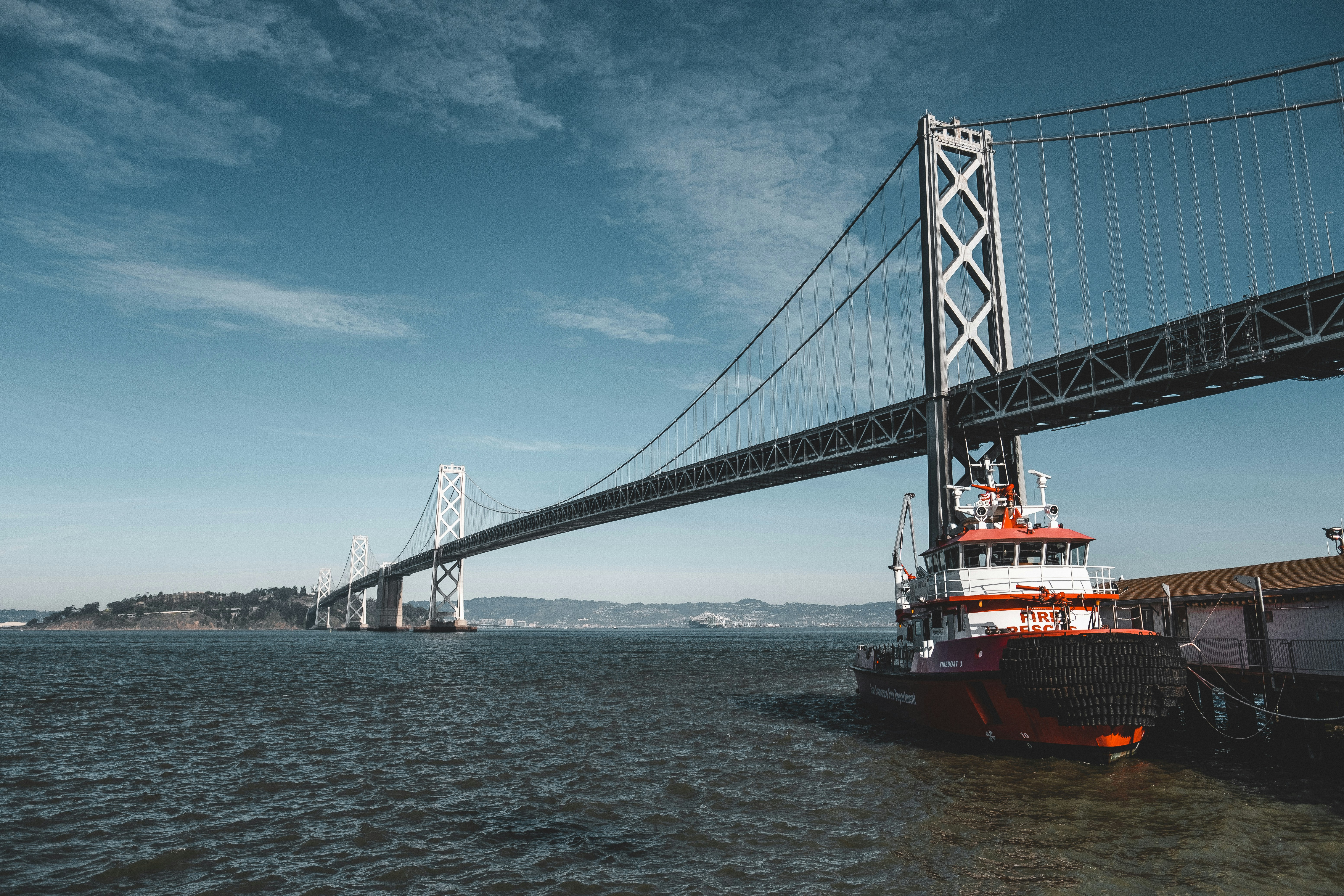 Red Tug at the Mooring Under a Looming Bay Bridge